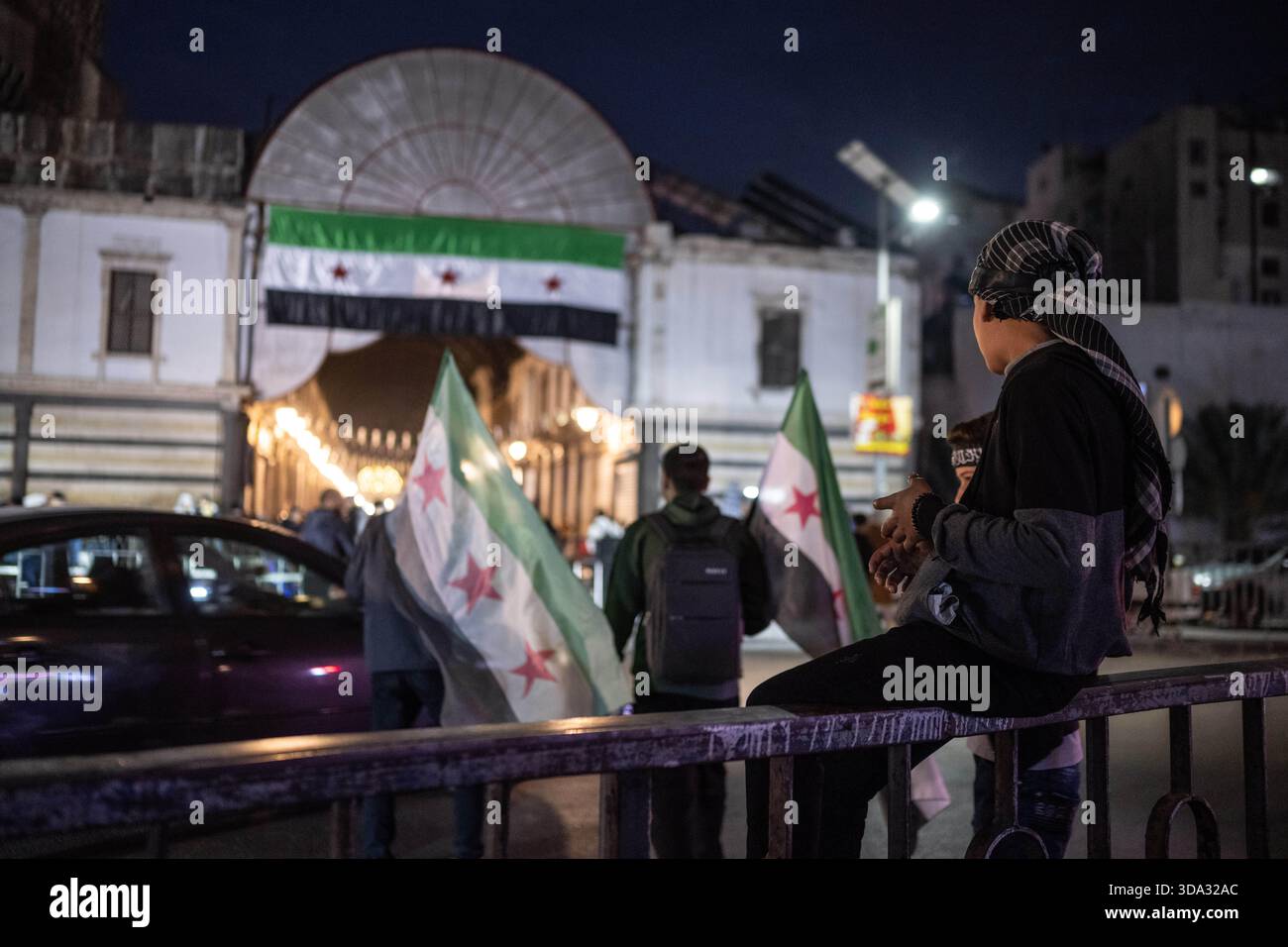 Syrian men with flags outside the entrance to Souq al Hamidiyeh ...