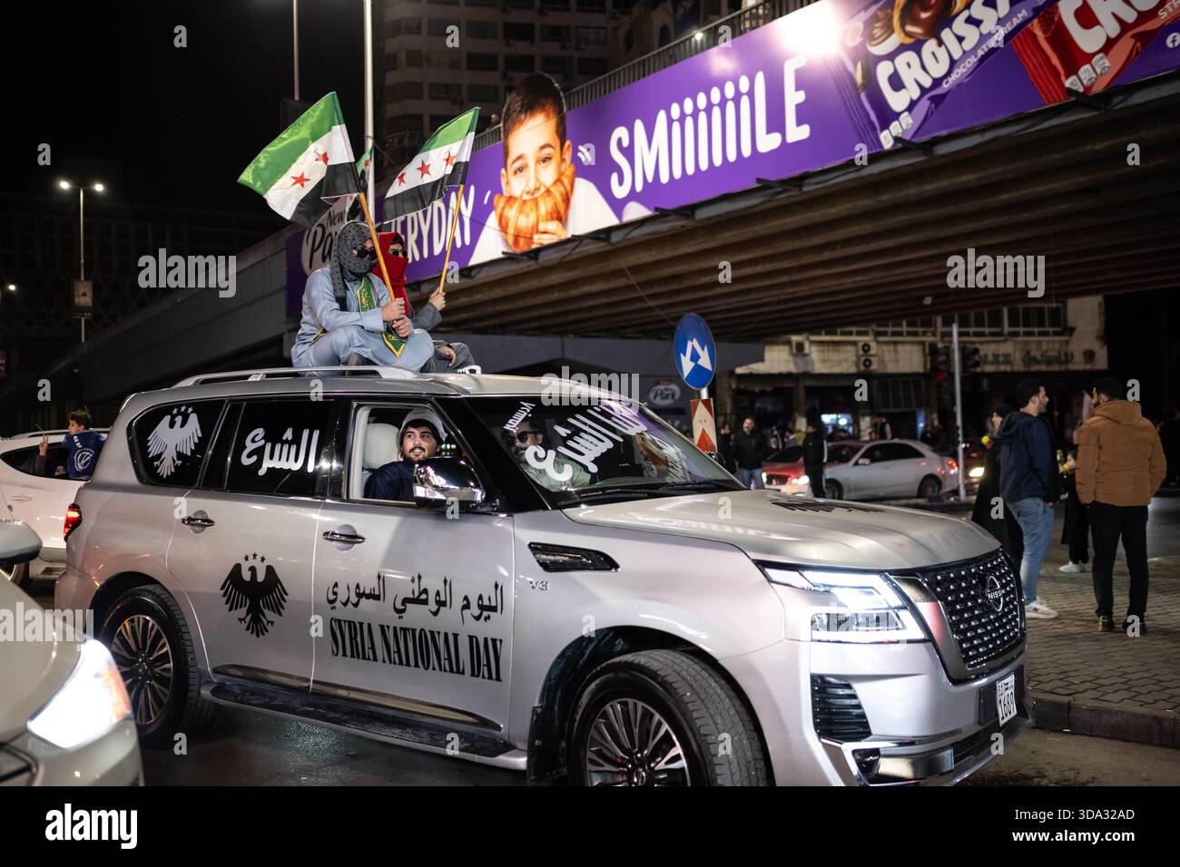Syrians wave flags and drive around the streets of Damascus in ...