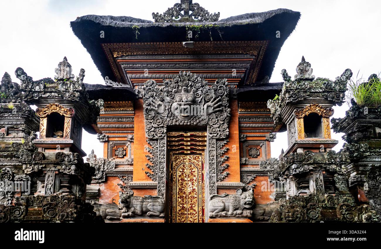 Ornate Balinese temple gate with intricate carvings and statues Stock ...