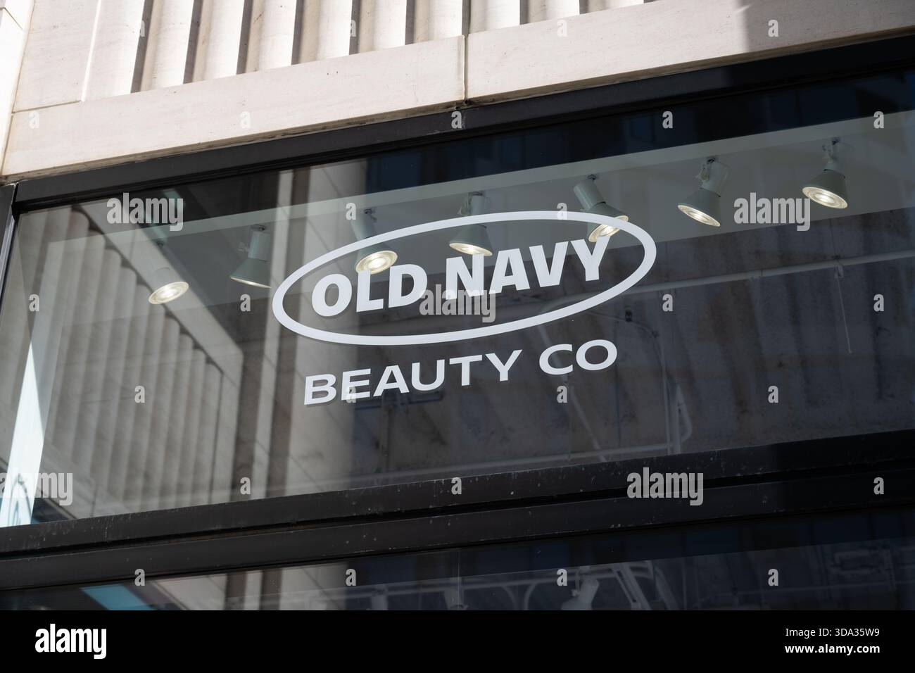 Storefront window with Old Navy Beauty Co logo and interior track ...