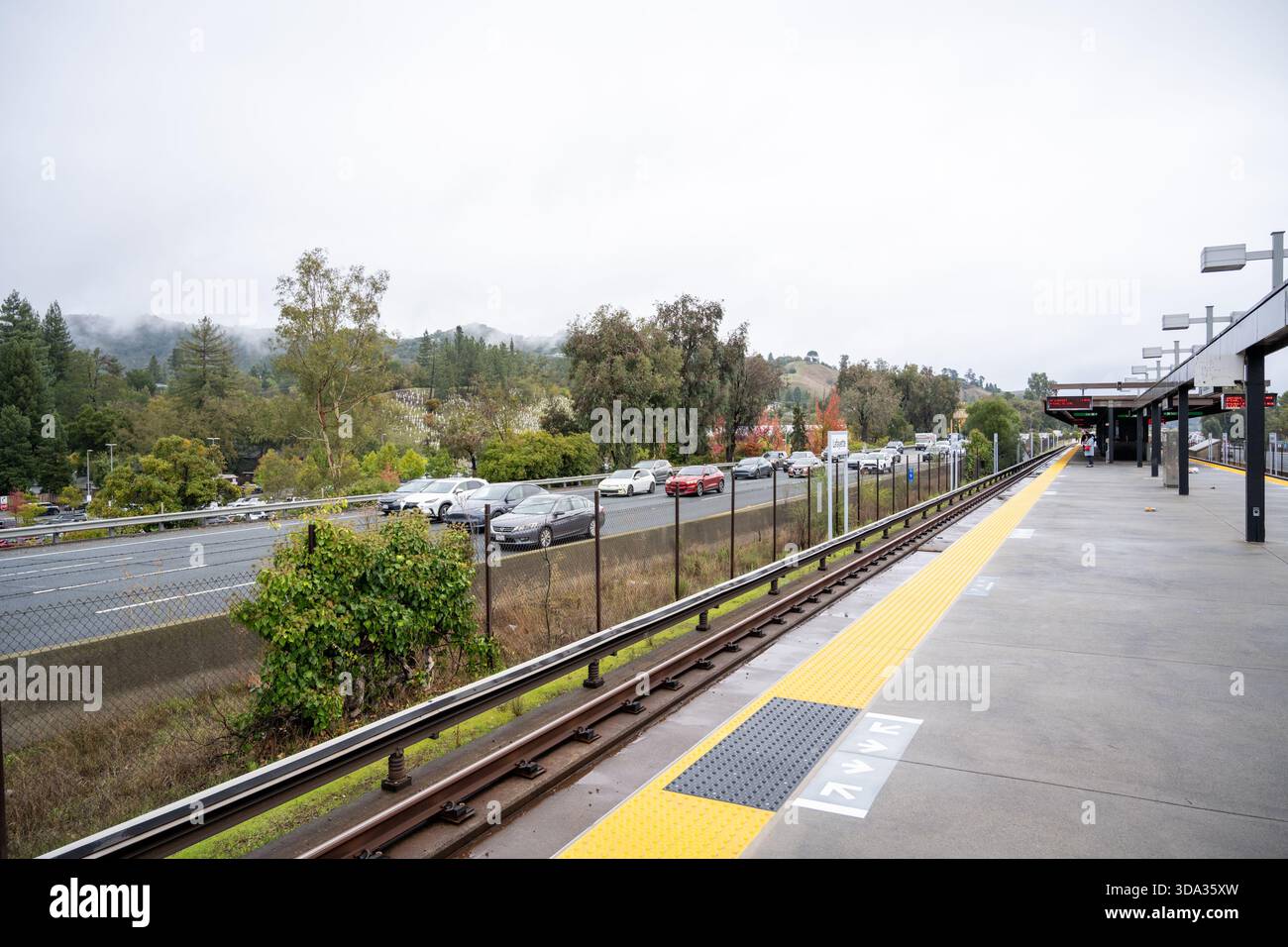 Station platform with traffic on Highway 24 in the background at ...