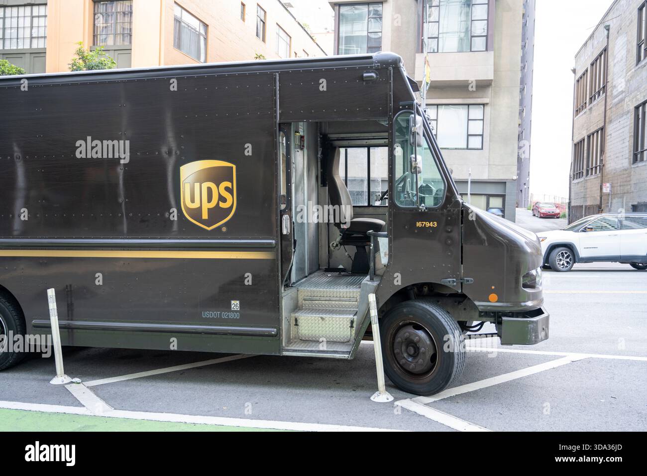 UPS delivery truck parked on city street with driver door open and logo ...