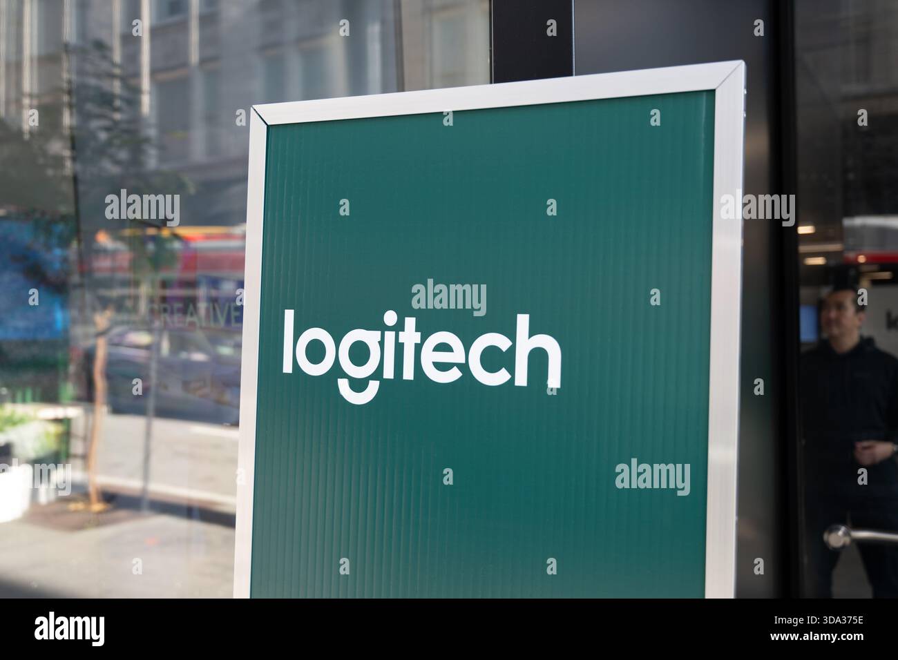 Close-up of Logitech logo on green sign outside retail storefront, San ...