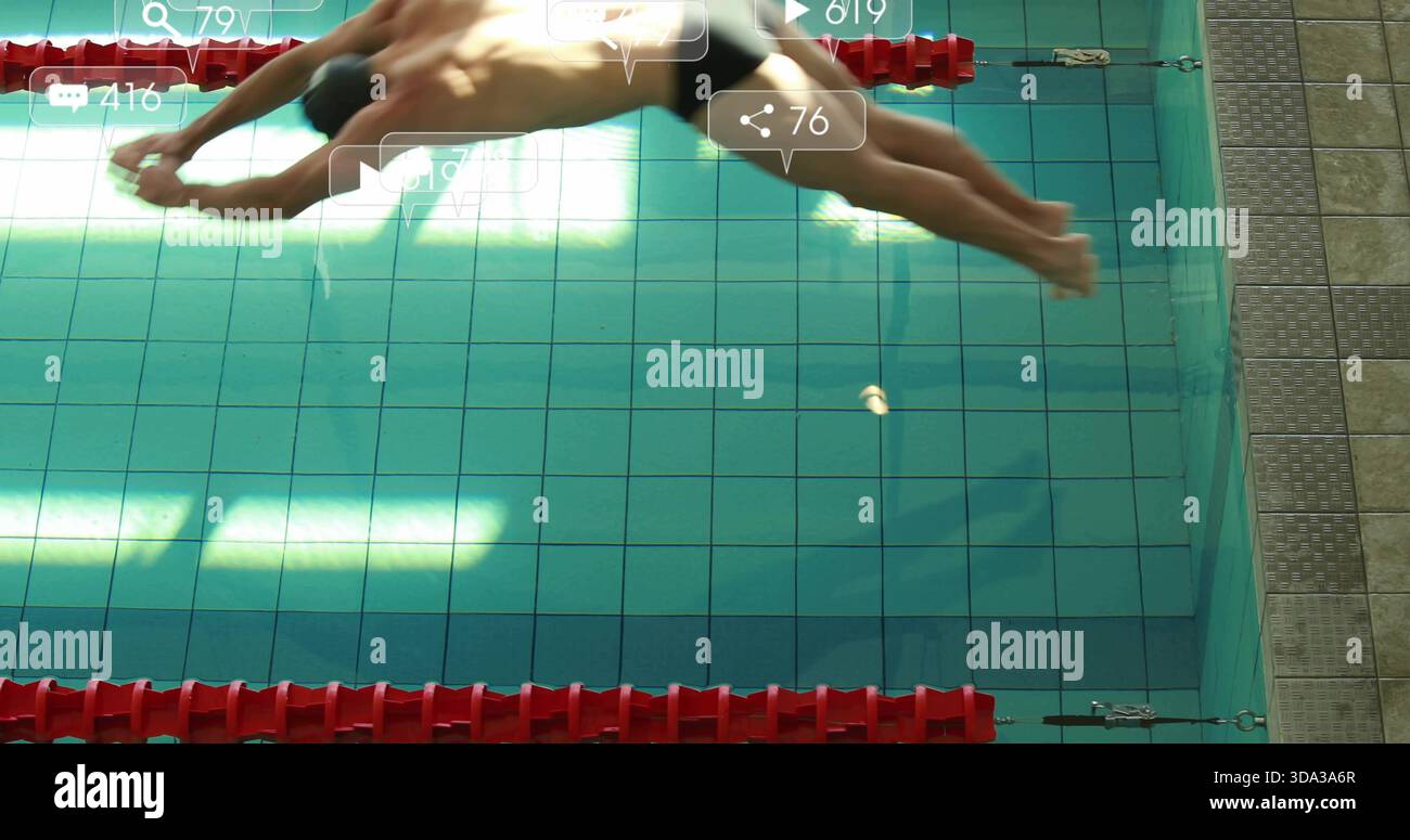 Diving male swimmer arcing into turquoise lap pool, wearing dark briefs ...