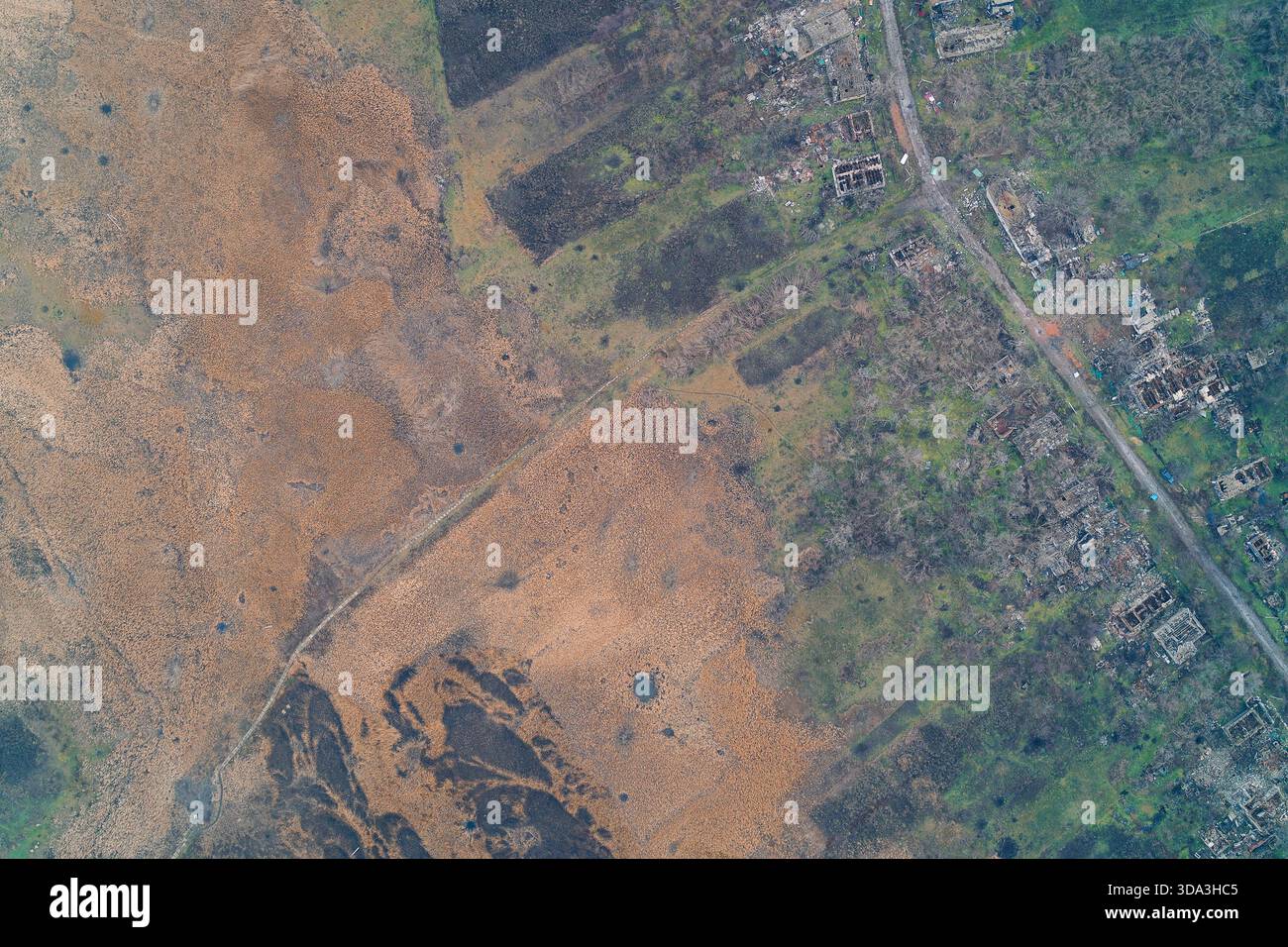 Aerial drone shot of a completely destroyed settlement with roofless ...