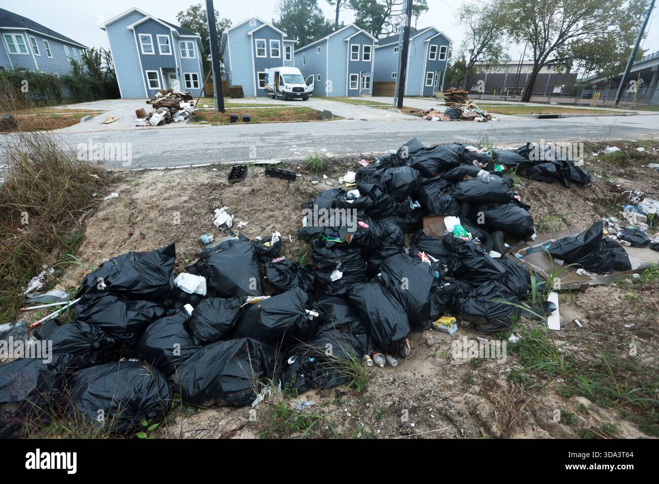 Piles of trash fill the ditch across a construction site in the Trinity ...