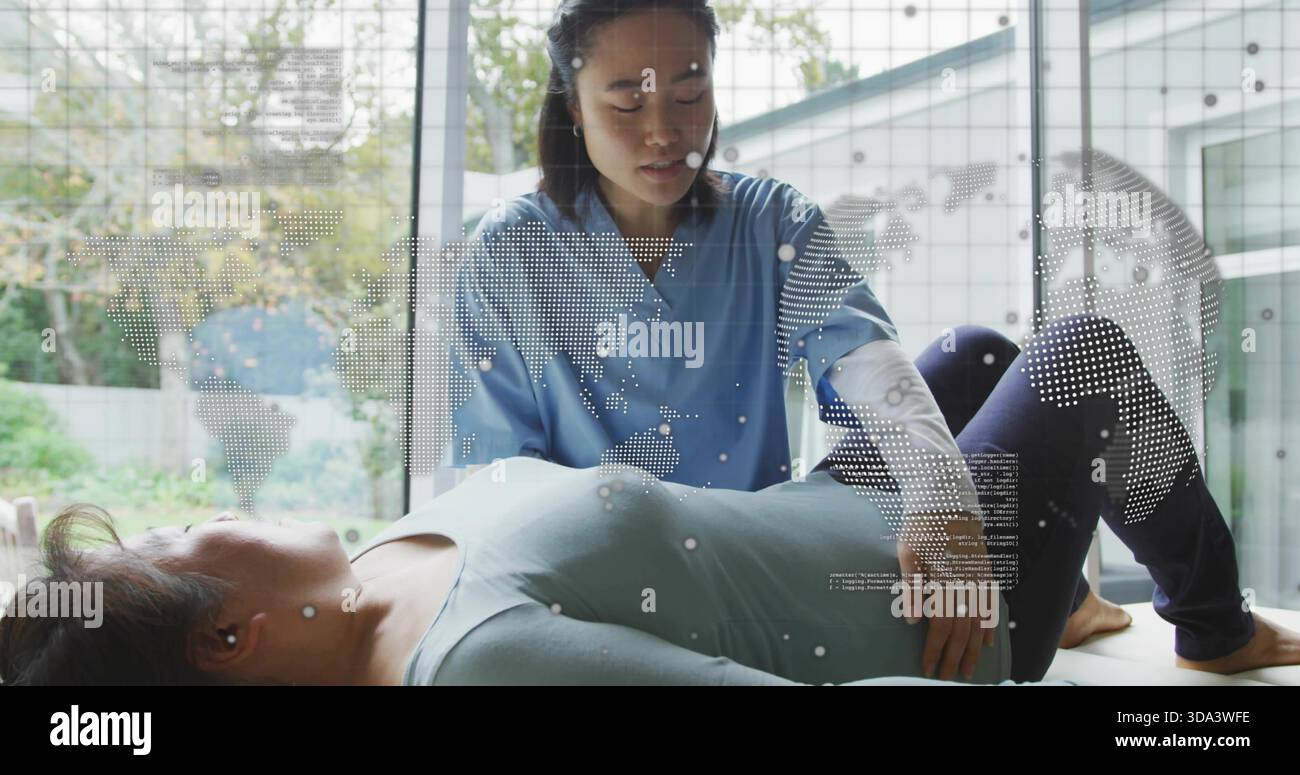 Examining patient, female provider in scrubs kneeling pressing abdomen ...