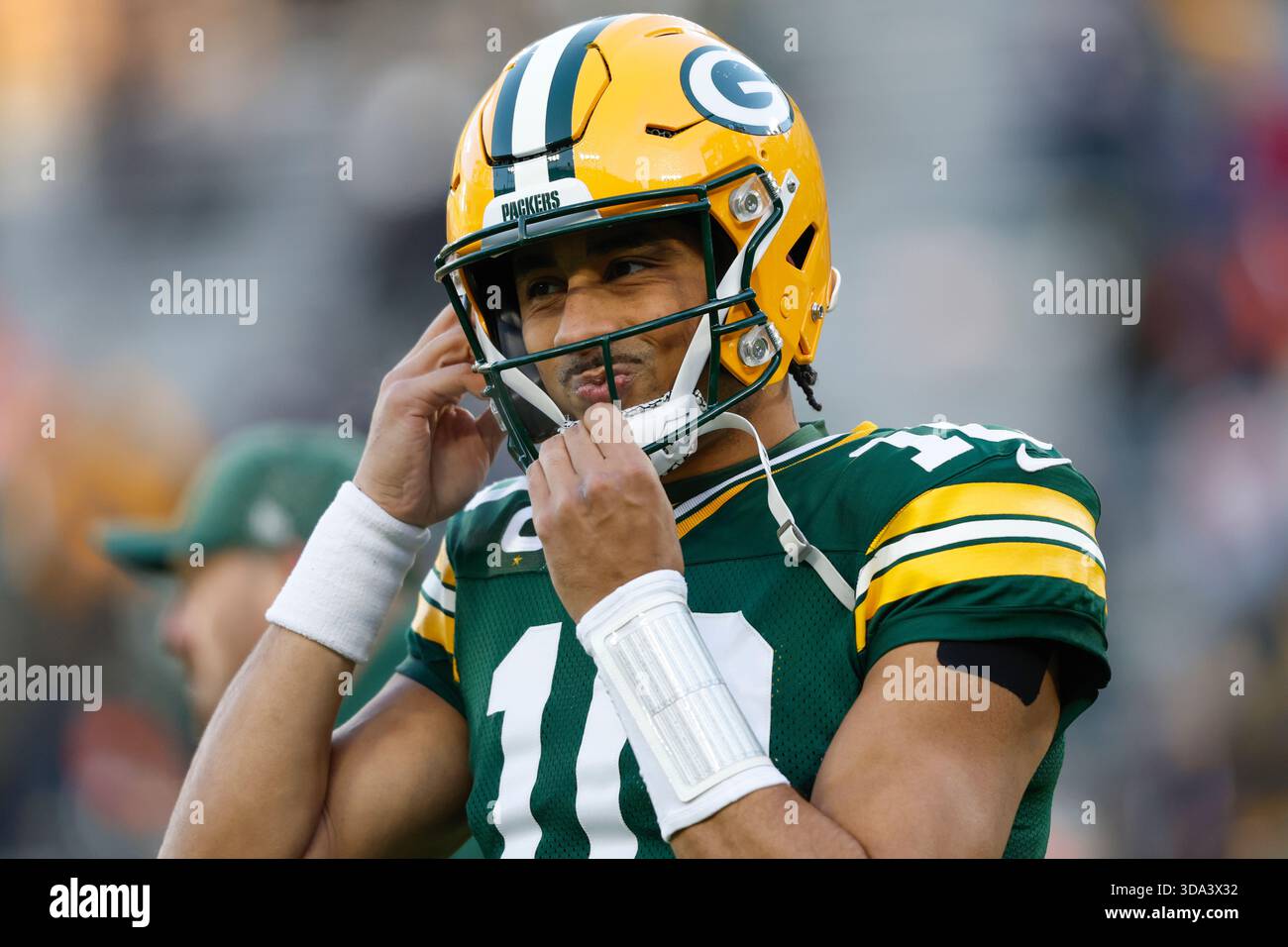 Green Bay Packers quarterback Jordan Love (10) adjusts his helmet ...