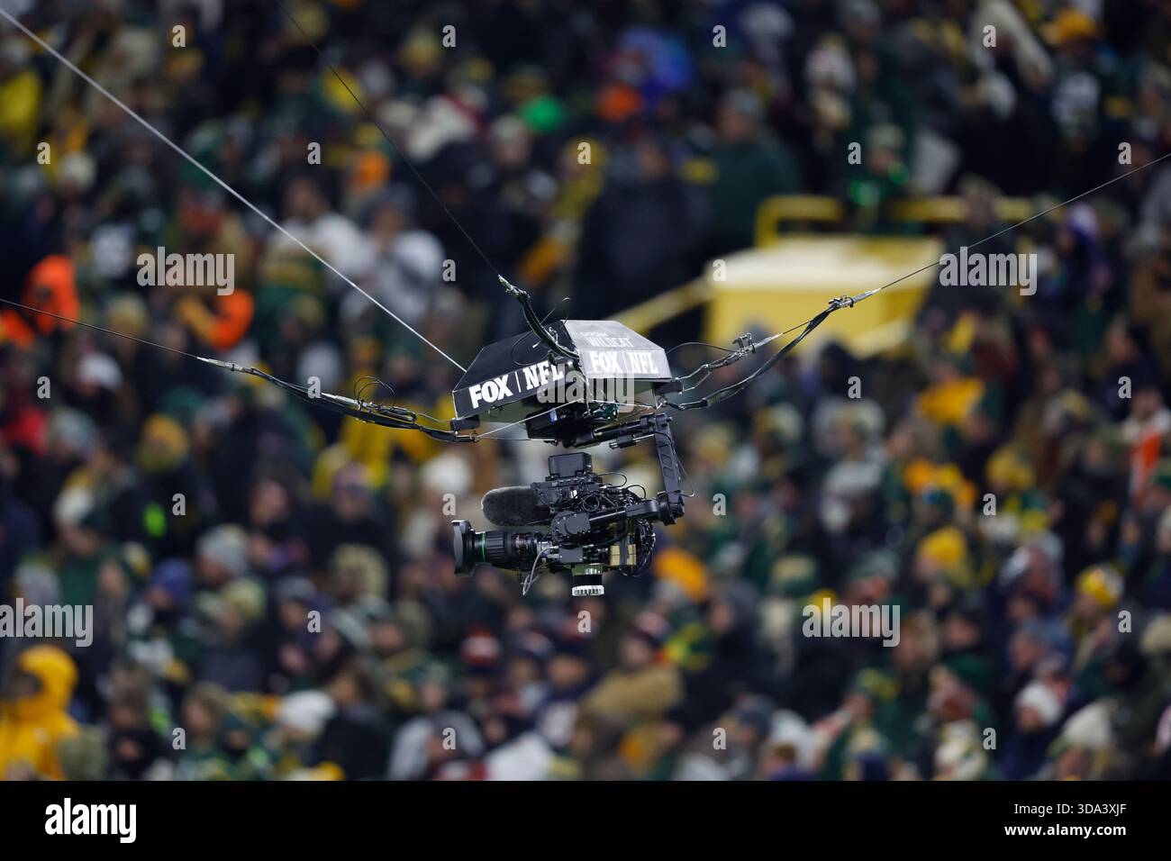 A Fox television remote camera hovers over the field during an NFL game ...