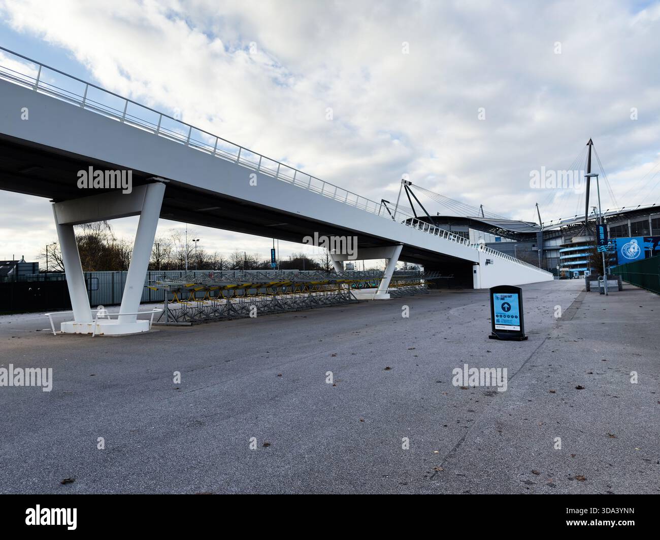 Manchester, UK - November 16, 2025: A modern white bridge spans a wide ...
