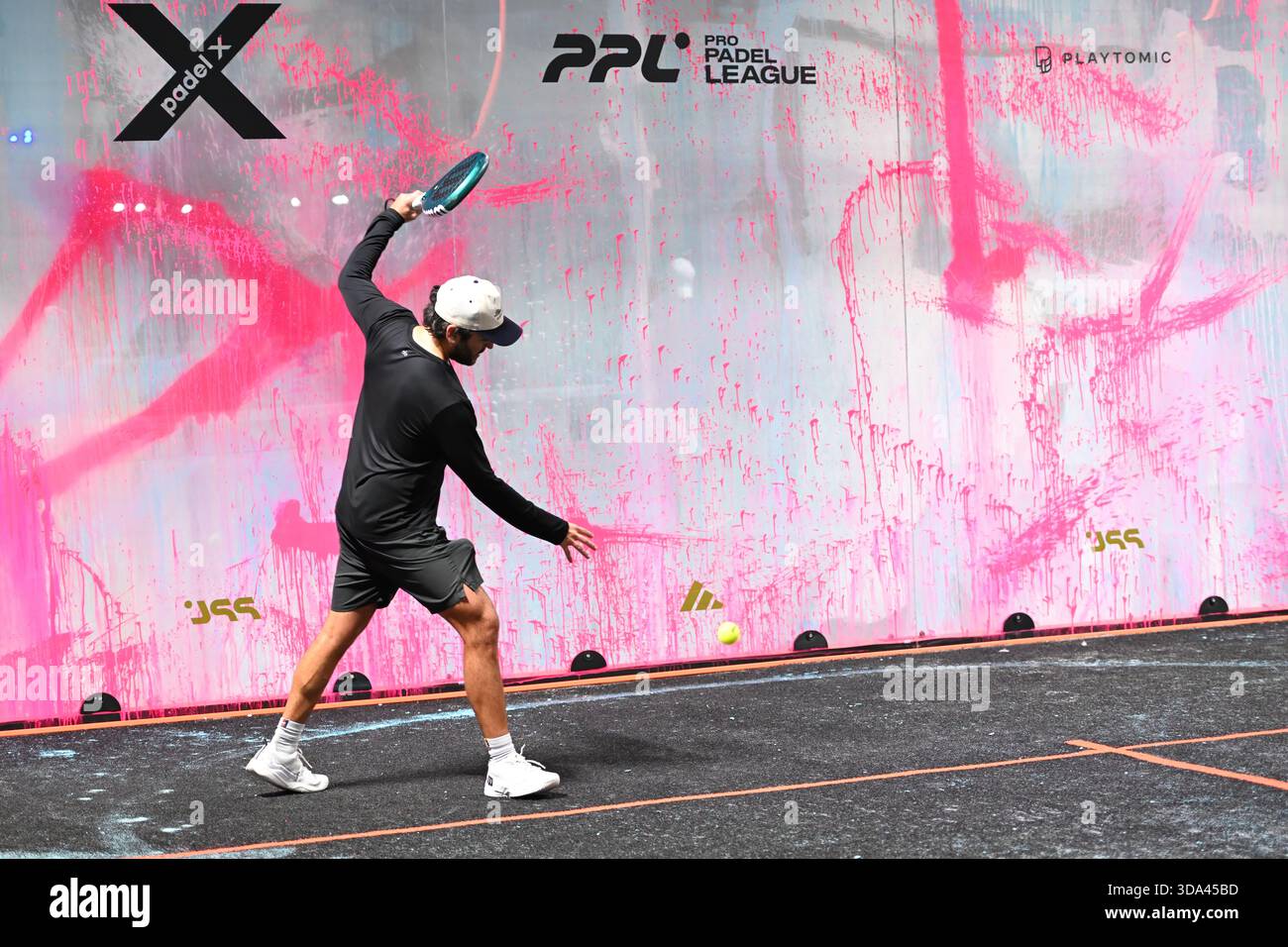 Hank Medina plays padel on a court painted by artist Ryan Keeley at Scope Miami Beach 2025 on ...