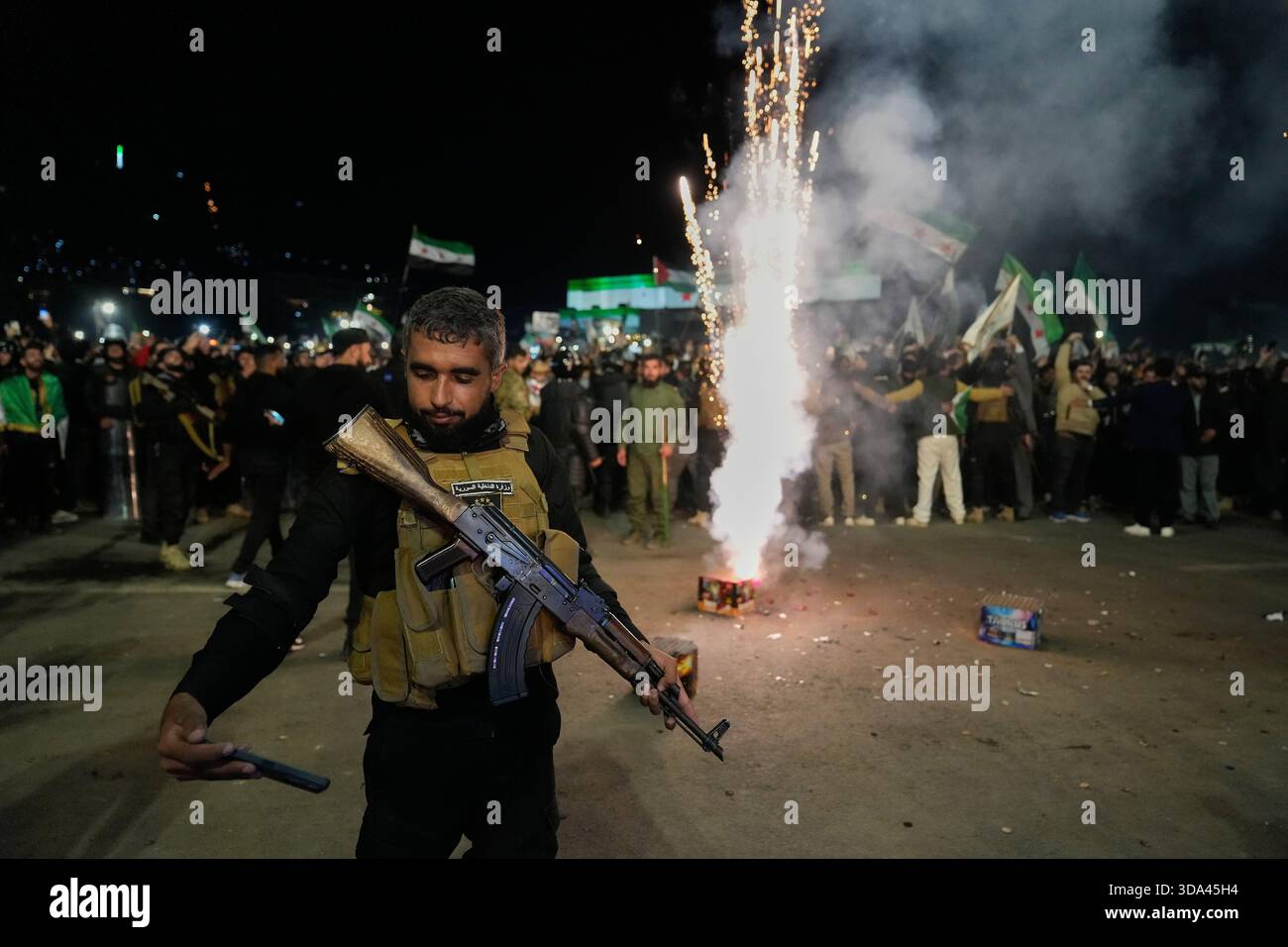 A Syrian policeman takes a selfie with the fireworks during ...