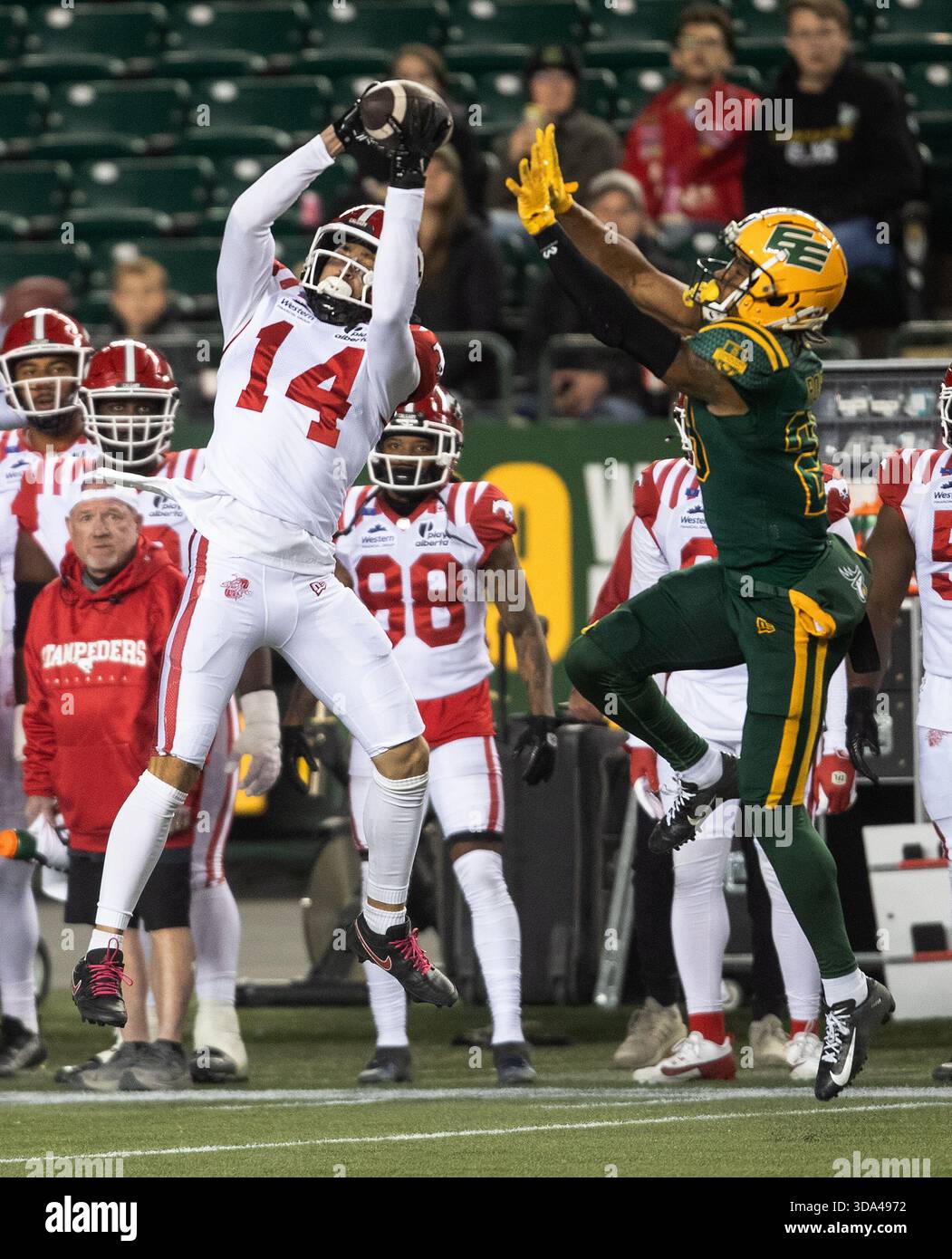 Calgary Stampeders' Clark Barnes (14) and Edmonton Elks' JJ Ross (29 ...