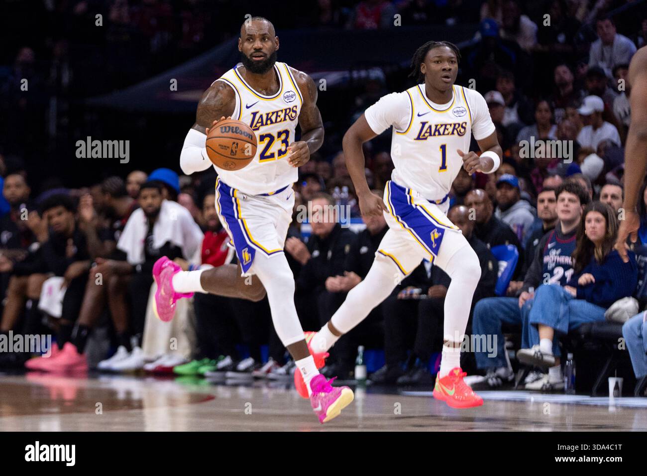 Los Angeles Lakers' LeBron James, left, brings the ball up the court ...