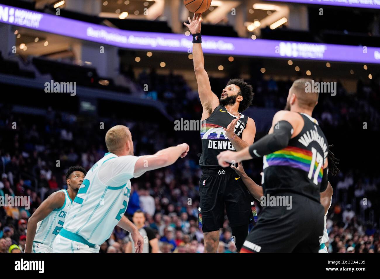 Denver Nuggets guard Jamal Murray (27) goes to the basket defended by ...