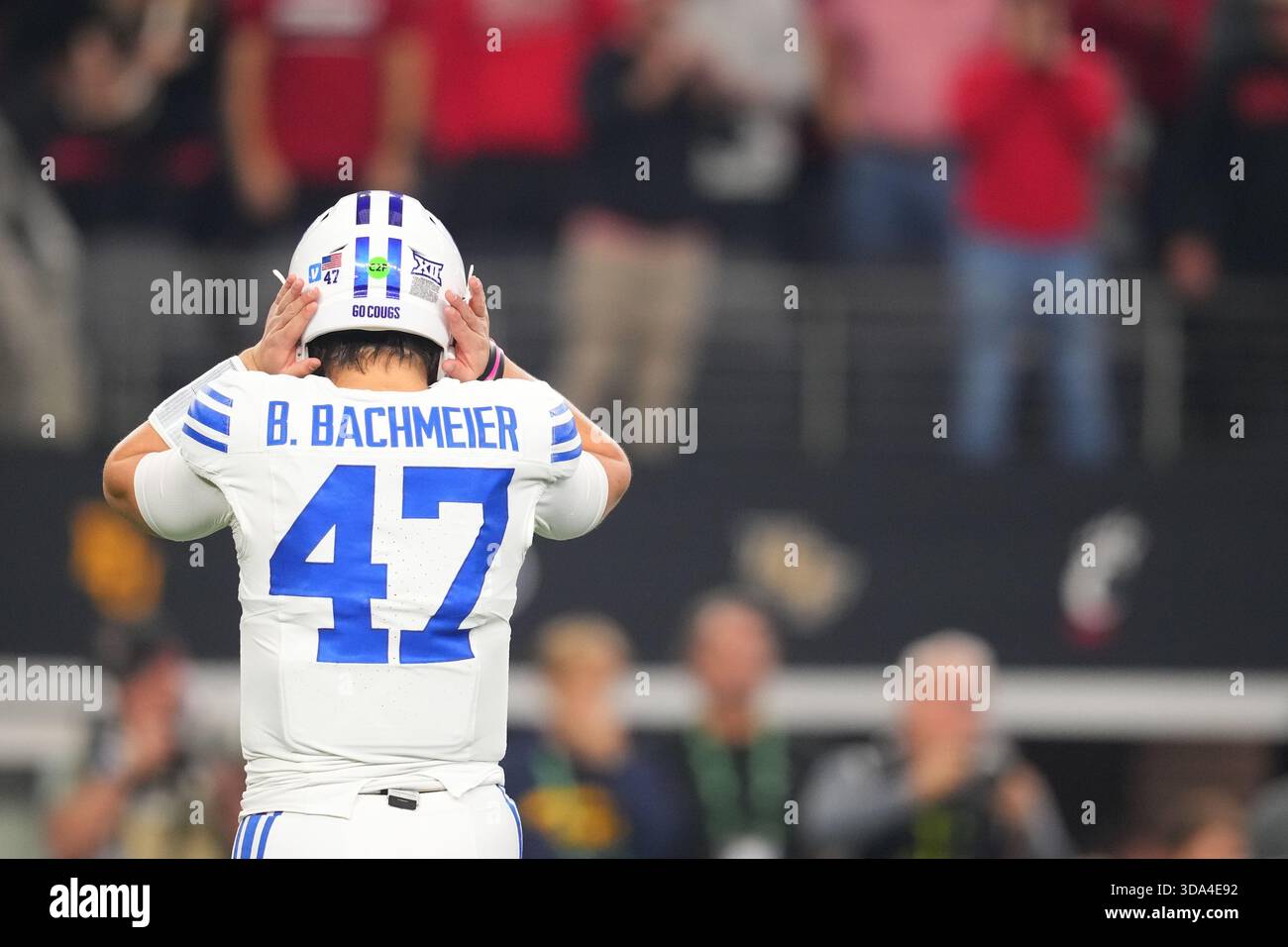 BYU quarterback Bear Bachmeier (47) covers his ears before running a ...