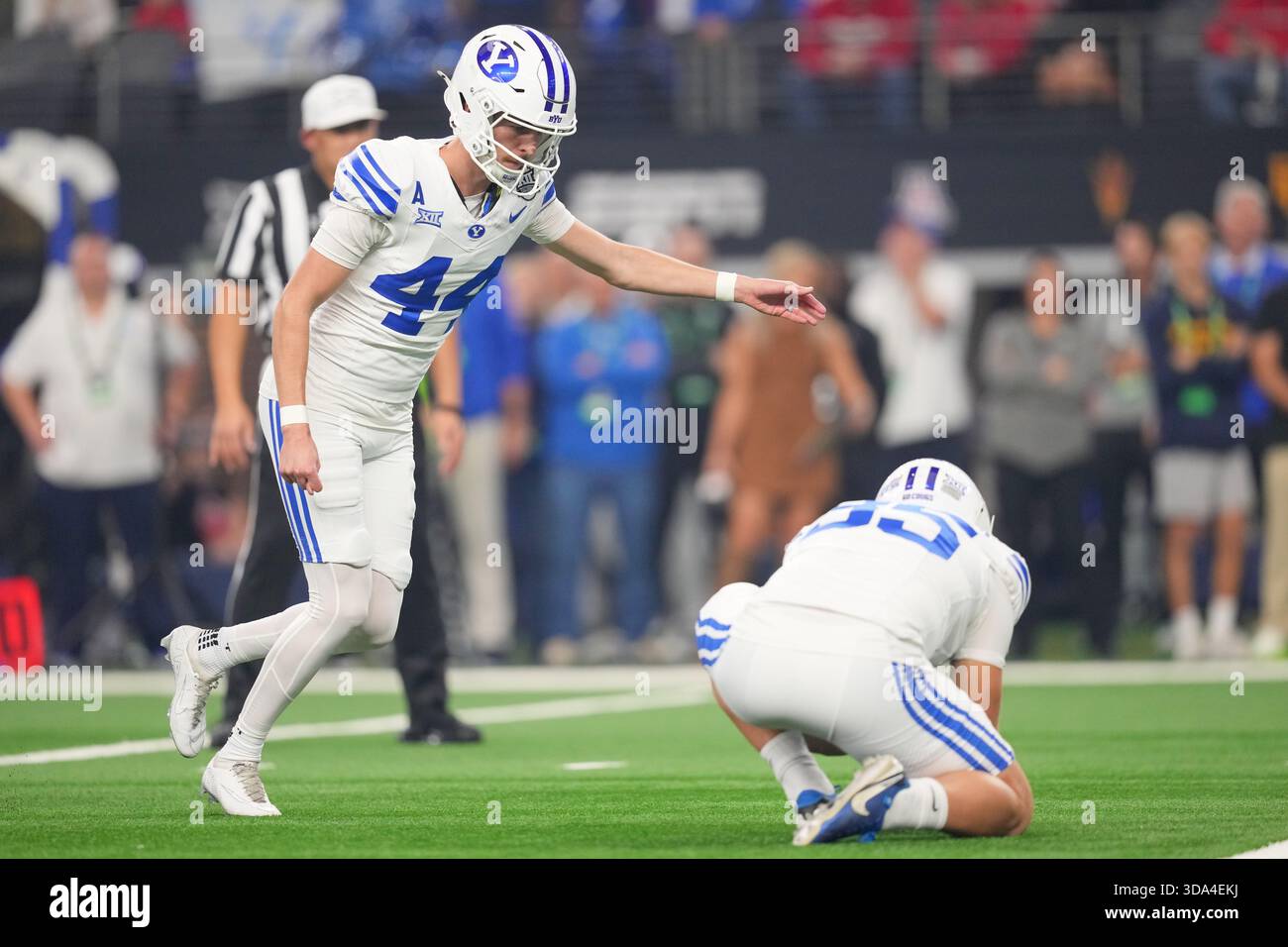 BYU kicker Will Ferrin (44), with punter Sam Vander Haar holding, kicks ...