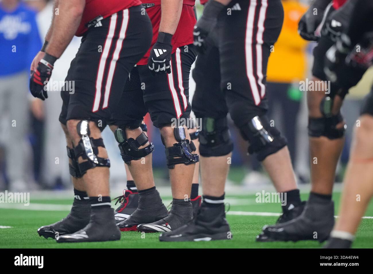 Knee braces worn by Texas Tech offensive line players are visible ...