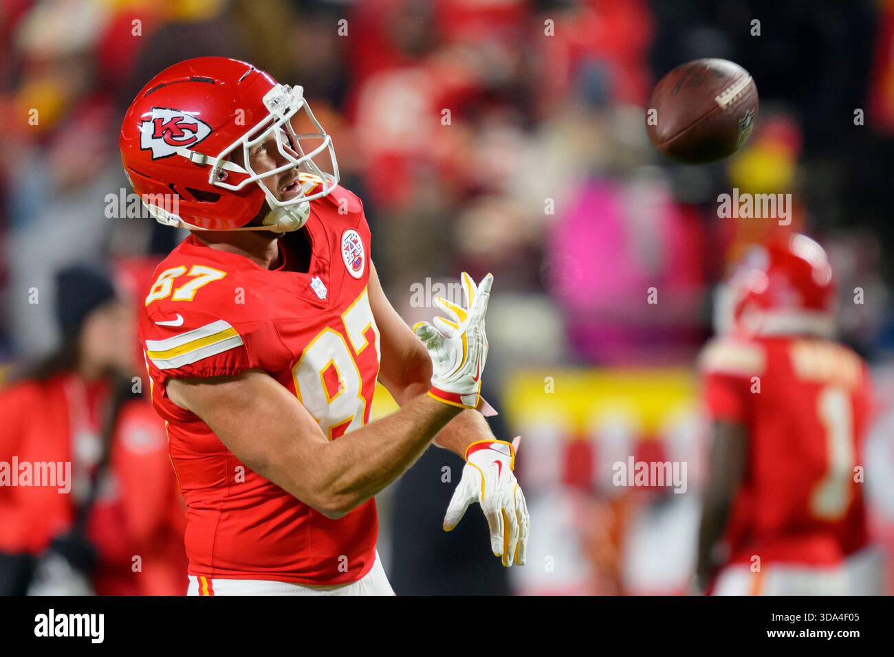 Kansas City Chiefs tight end Travis Kelce tosses the ball back to an assistant during warmups ...