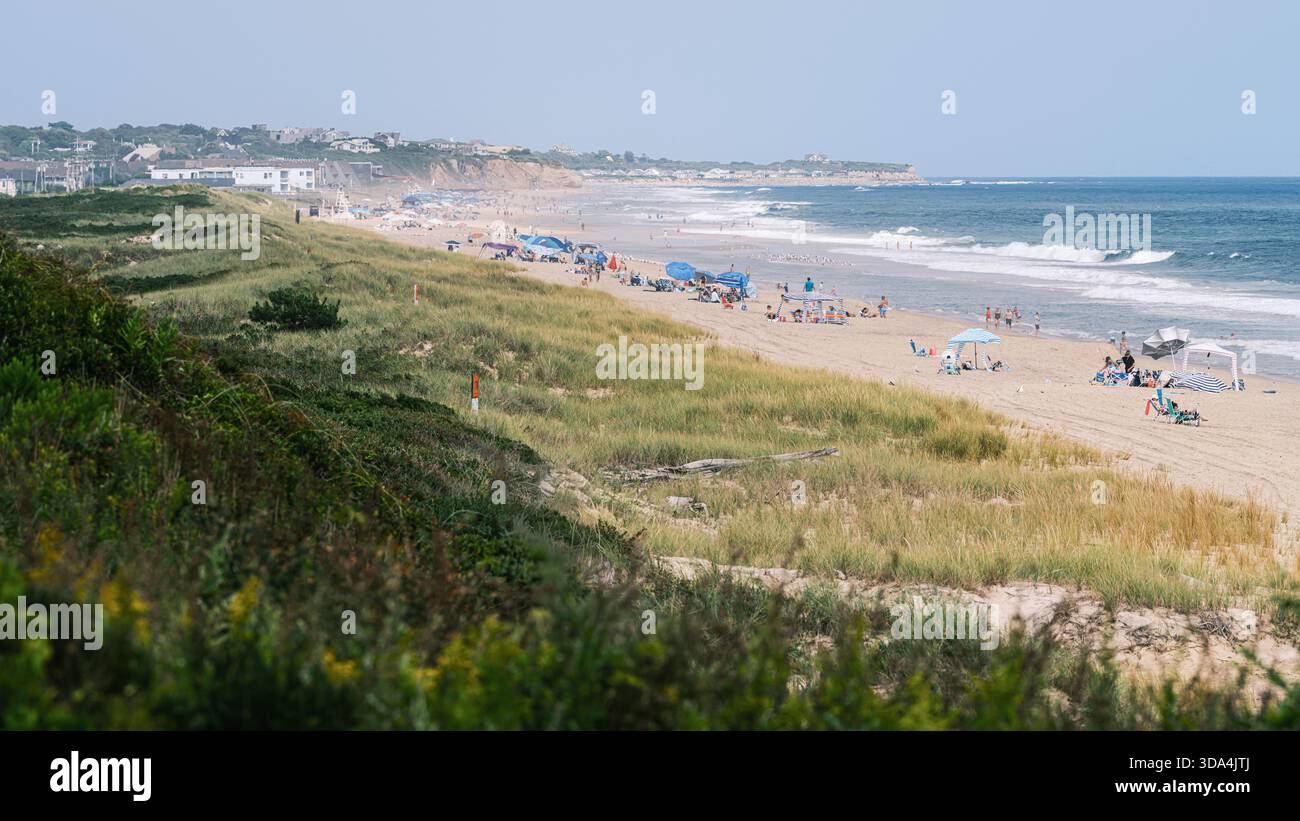 Beachgoers along the dunes in Montauk, Long Island, enjoying the summer ...