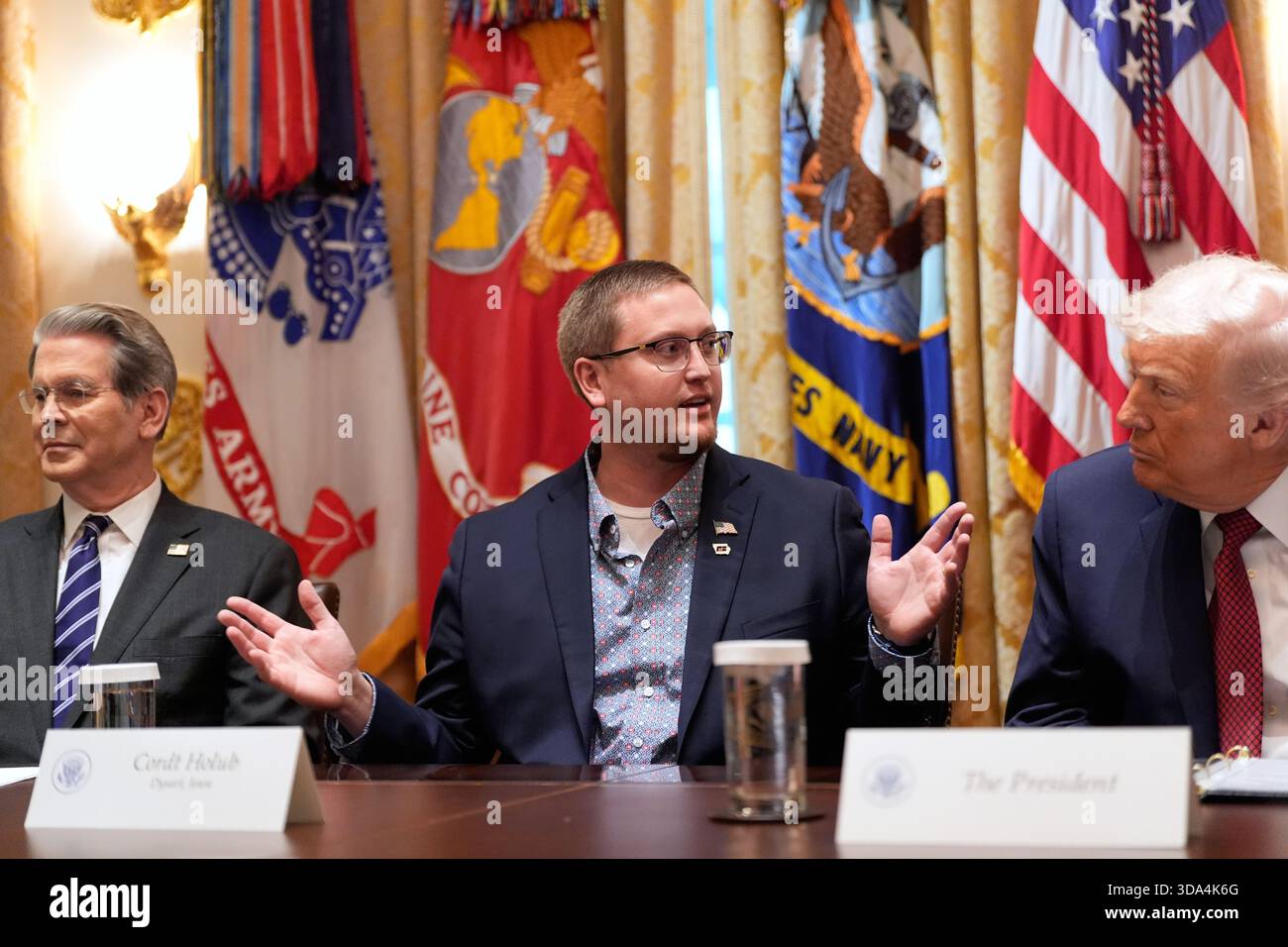 President Donald Trump and Treasury Secretary Scott Bessent listen as ...