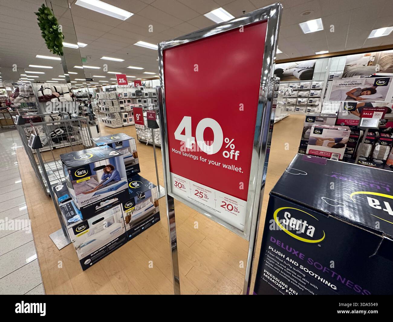 A sign shows the discount available on items in a Kohl's department ...
