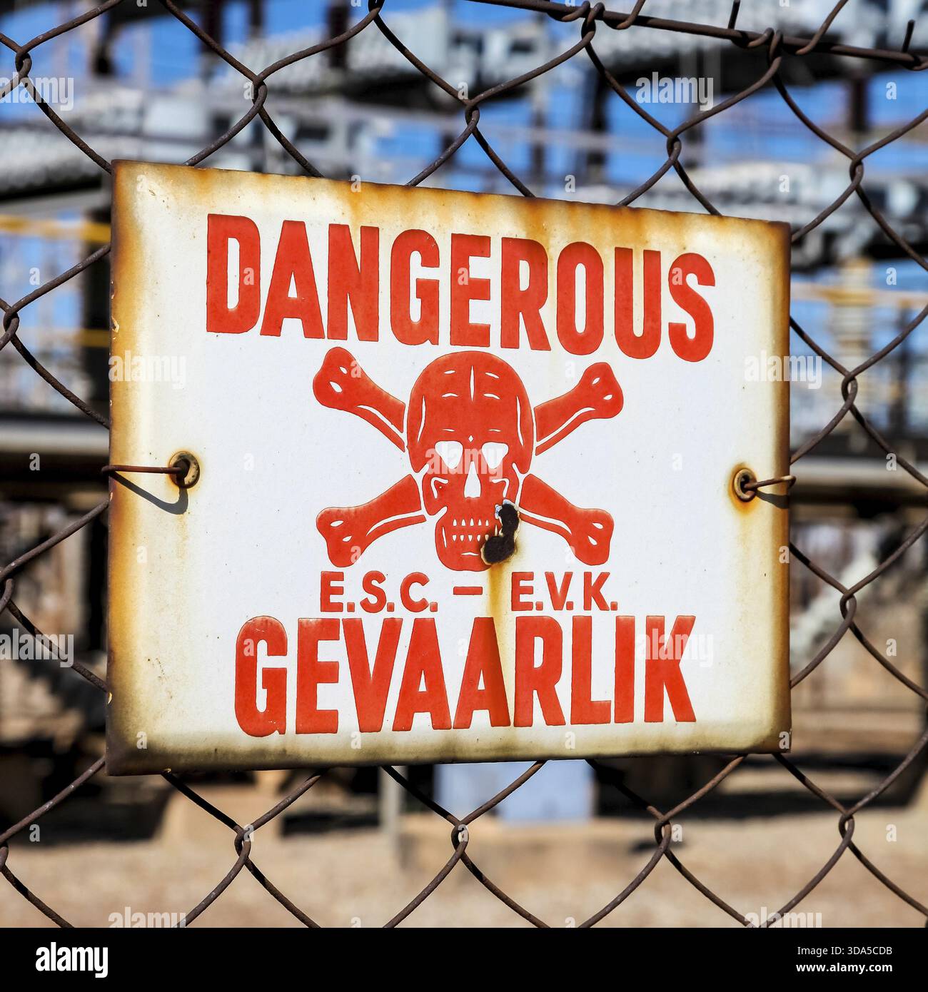 Danger Sign on a fence in English and Afrikaans language Stock Photo ...