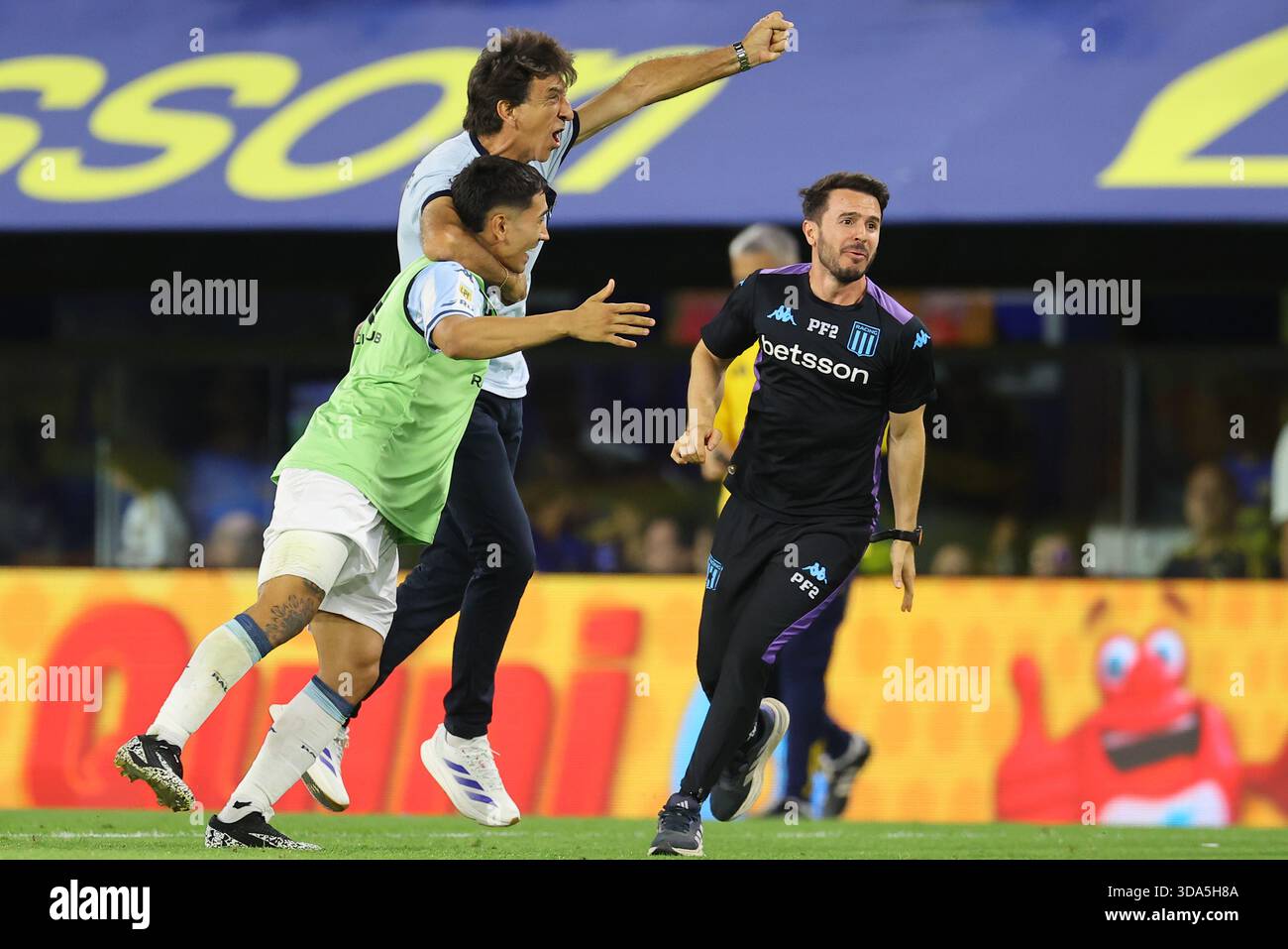 Racing Club’s head coach Gustavo Costas (C) celebrates with forward ...