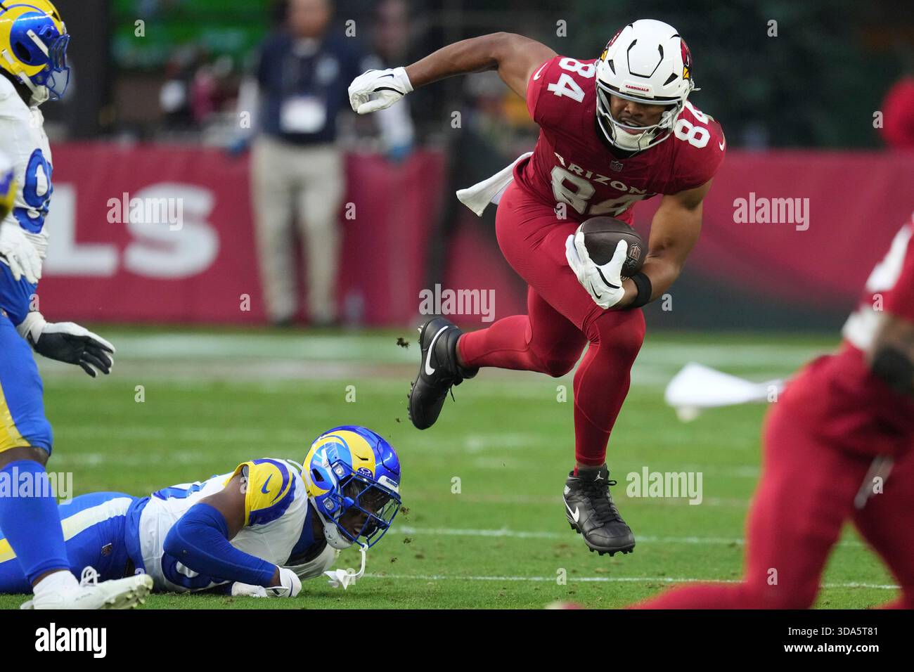 Arizona Cardinals tight end Elijah Higgins (84) gets tripped up by Los ...
