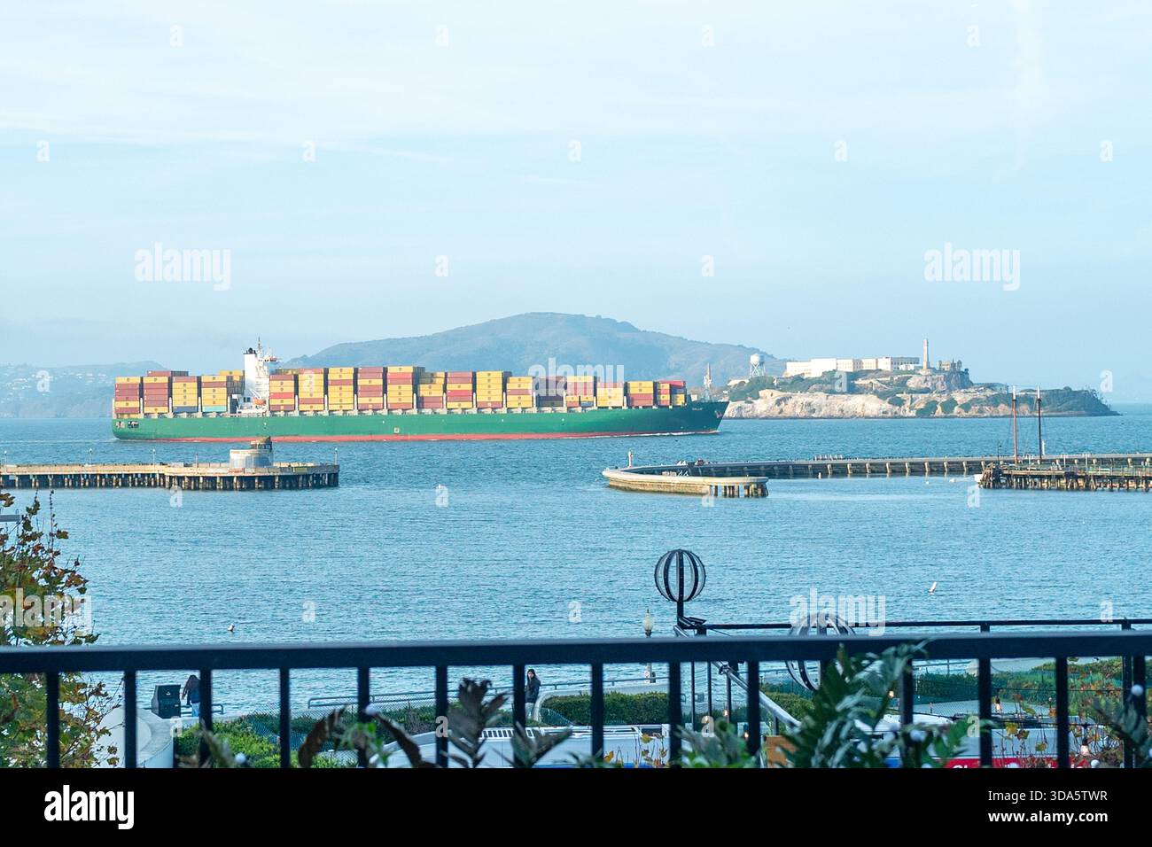A large container ship is visible passing by Alcatraz Island in the San ...
