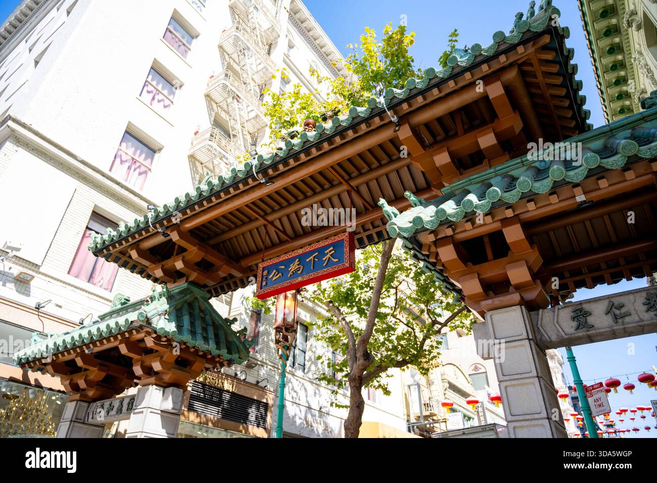 Traditional Chinese-style Dragon Gate gateway with green tiled roof and ...