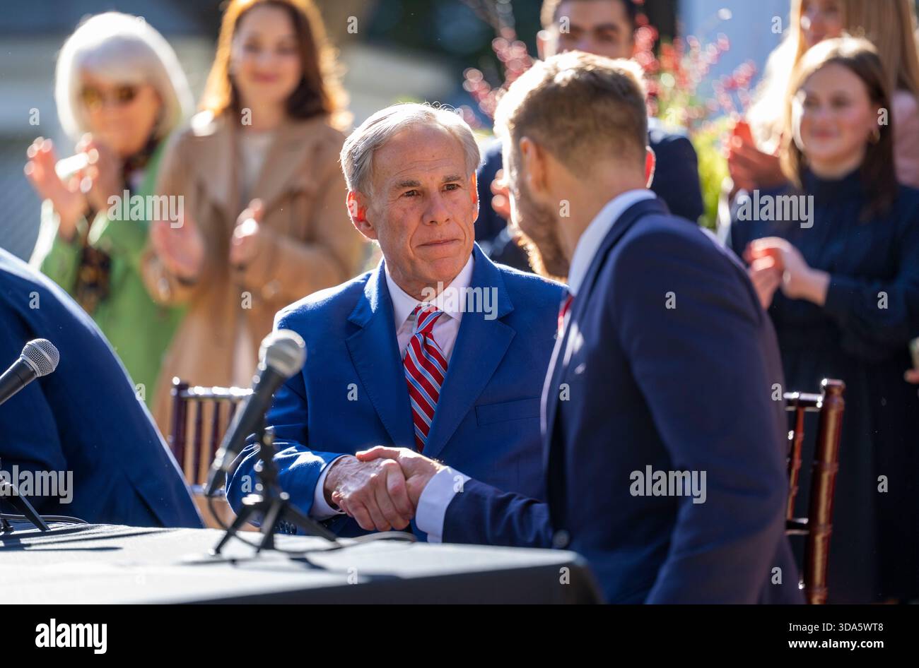 Texas Governor GREG ABBOTT shakes hands with JOSH THIFAULT after announcing a partnership with ...