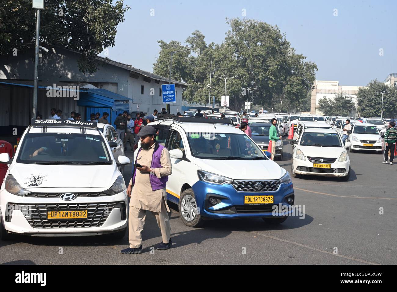 NEW DELHI, INDIA - DECEMBER 8: Ola, Uber and Rapido taxi at Taxi stand ...