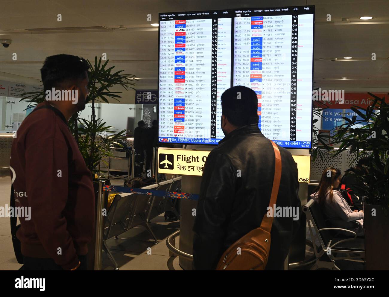 NEW DELHI, INDIA - DECEMBER 8: Passengers check Flight in Information ...