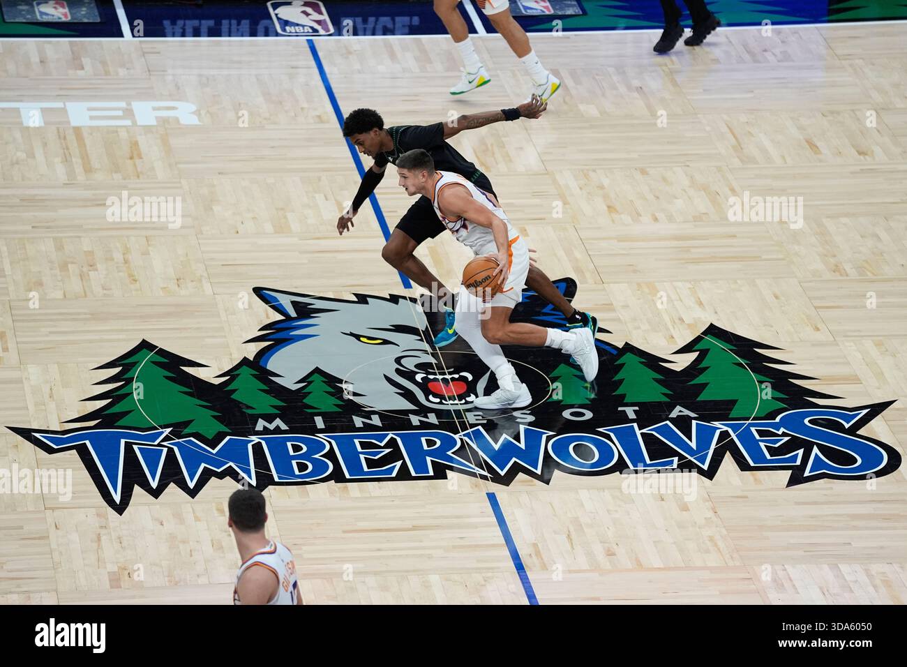 Phoenix Suns guard Grayson Allen, front, dribbles down the court as ...