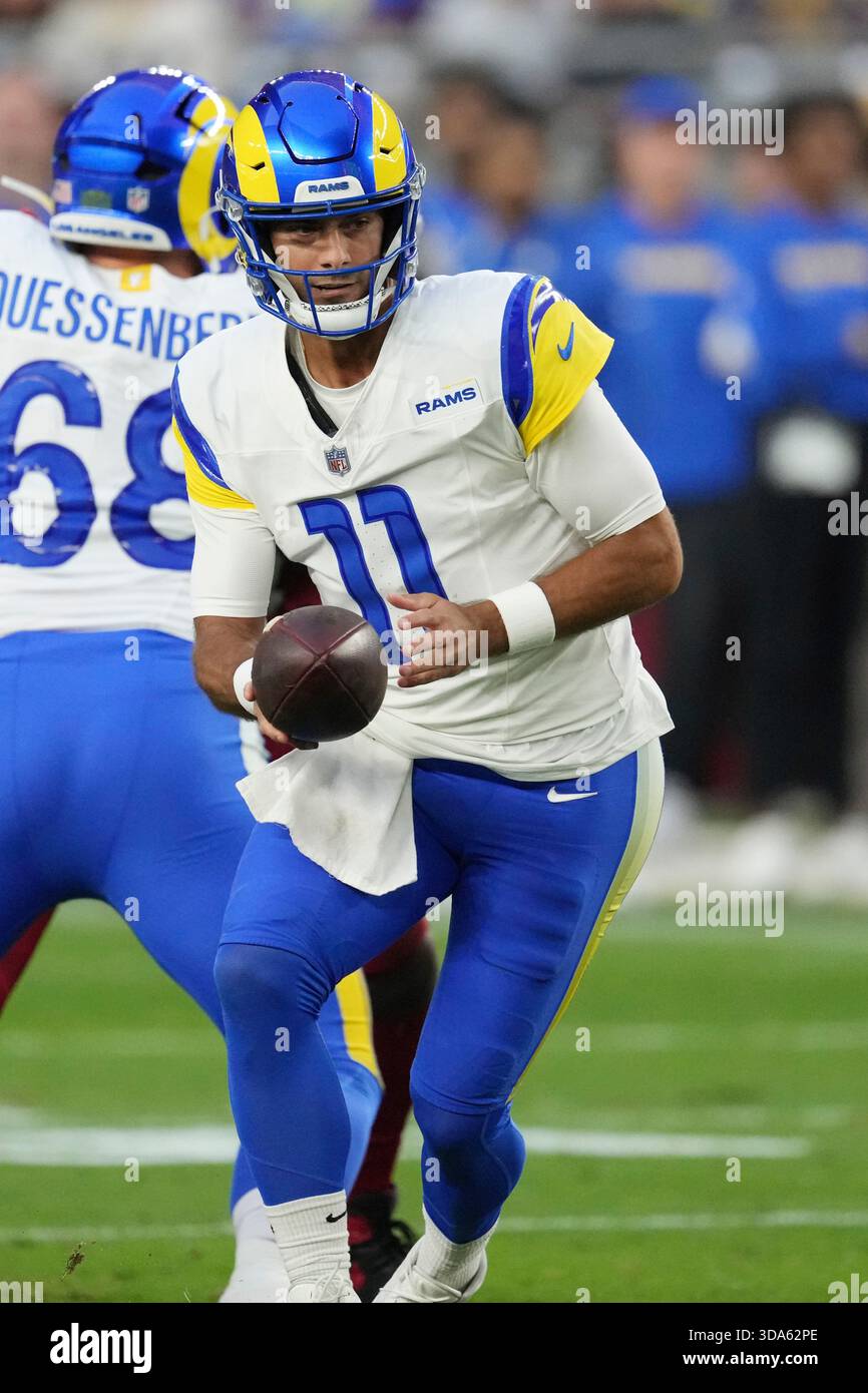 Los Angeles Rams quarterback Jimmy Garoppolo turns around the hand the ...