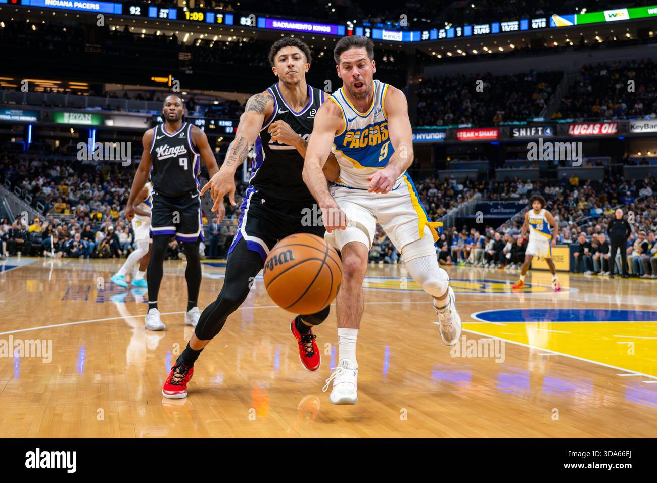 Sacramento Kings guard Nique Clifford, left, and Indiana Pacers guard T ...