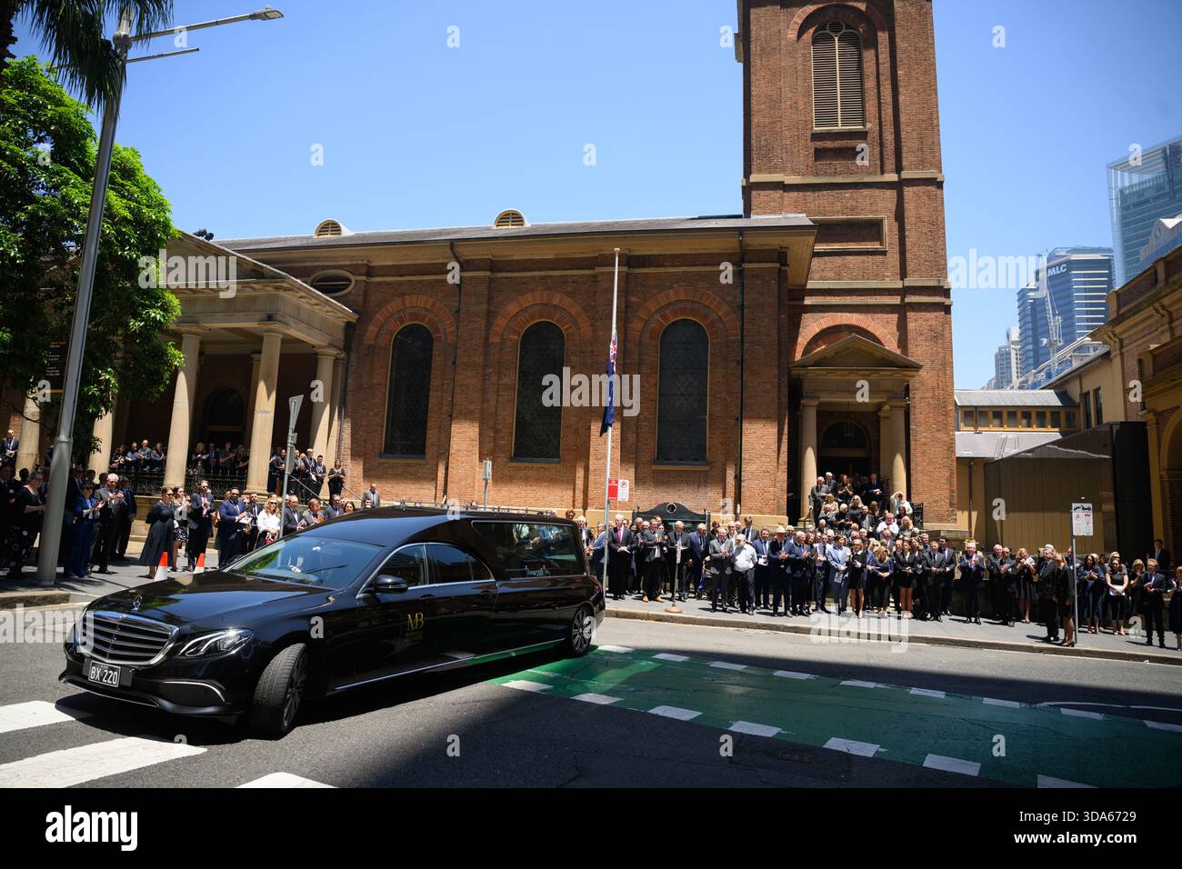 Mourners watch on as the procession departs the state funeral for ...