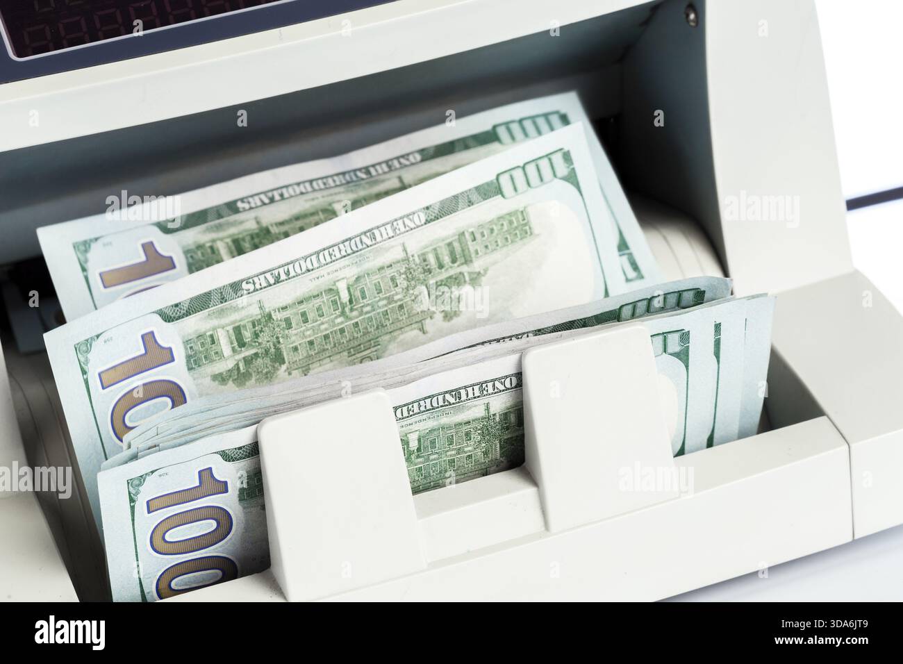 Cash counting machine processes several hundred dollar bills at a busy ...