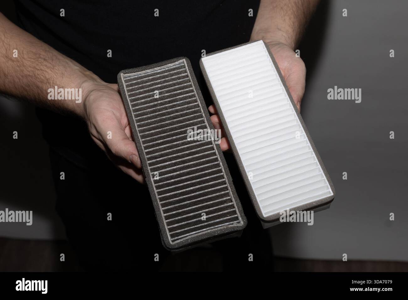 Heavily contaminated cabin air filter removed from a car, showing the ...