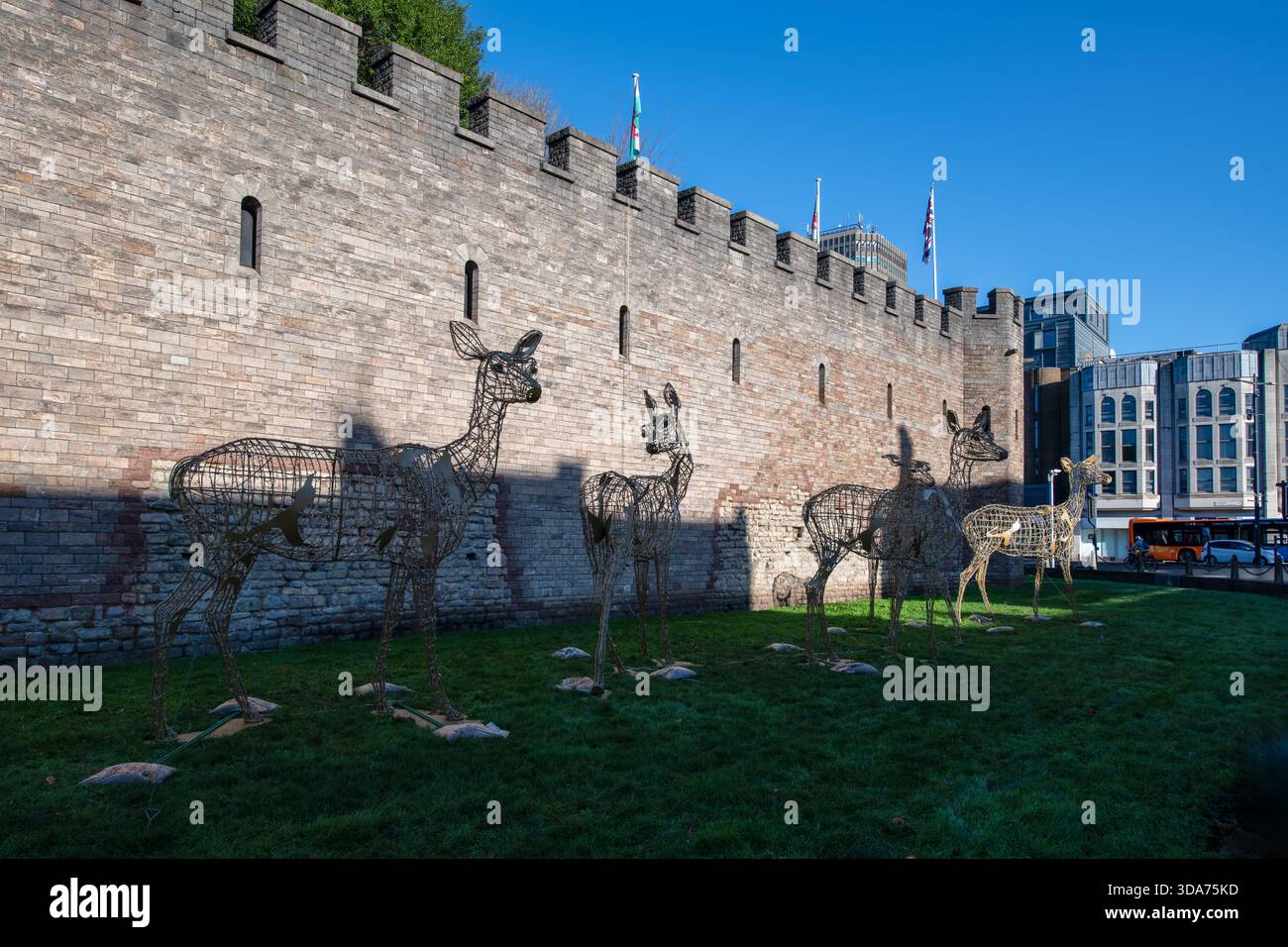 Wire-frame deer sculptures in winter sunlight outside the walls of ...