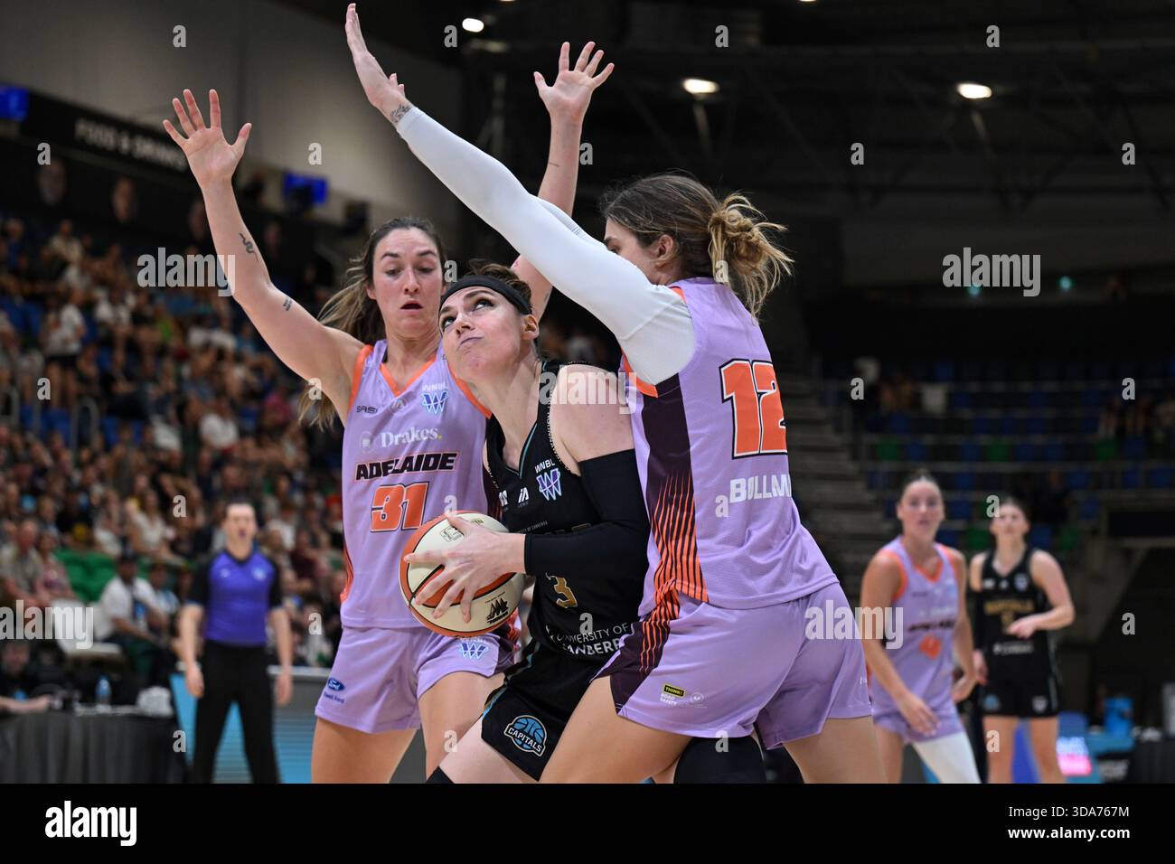 Teige Morrell of the Capitals fights for the ball with Erin Bollmann of ...