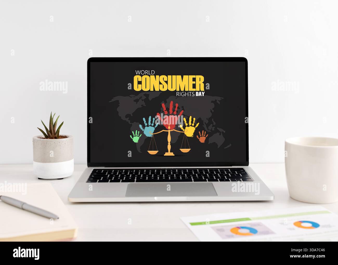 Laptop displaying World Consumer Rights Day graphic with hands and ...