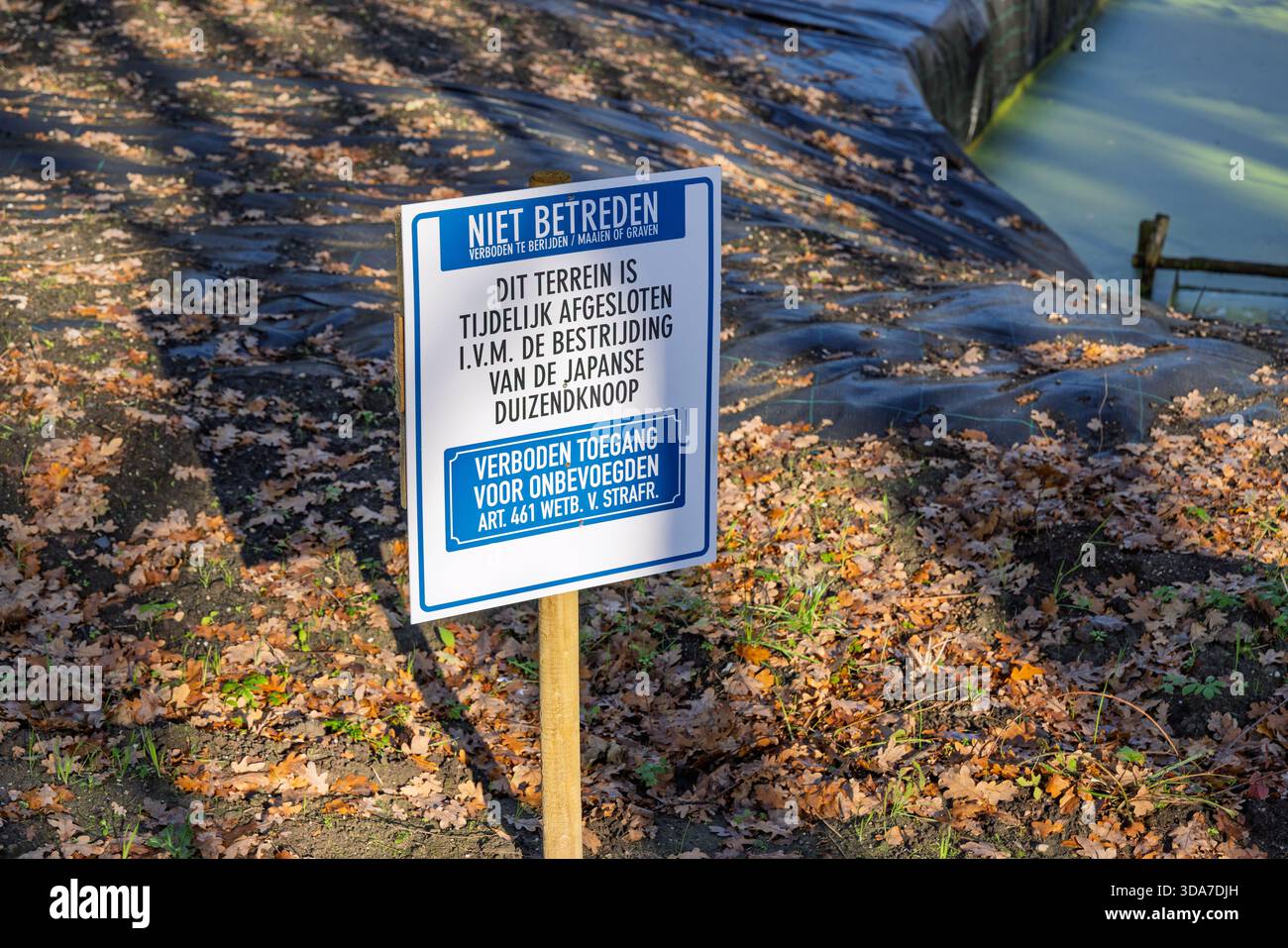 A warning sign in a Dutch park restricting access to an area covered in ...