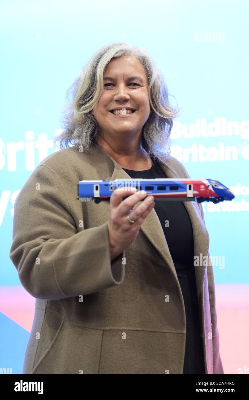 Transport Secretary Heidi Alexander holds a model train decorated with ...