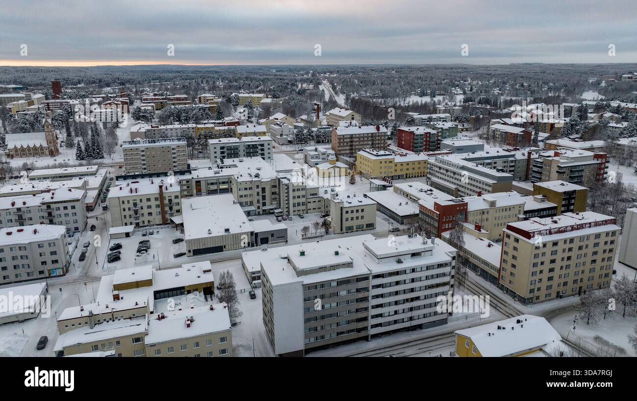 Aerial view of snow-dusted buildings casting long shadows under a muted ...