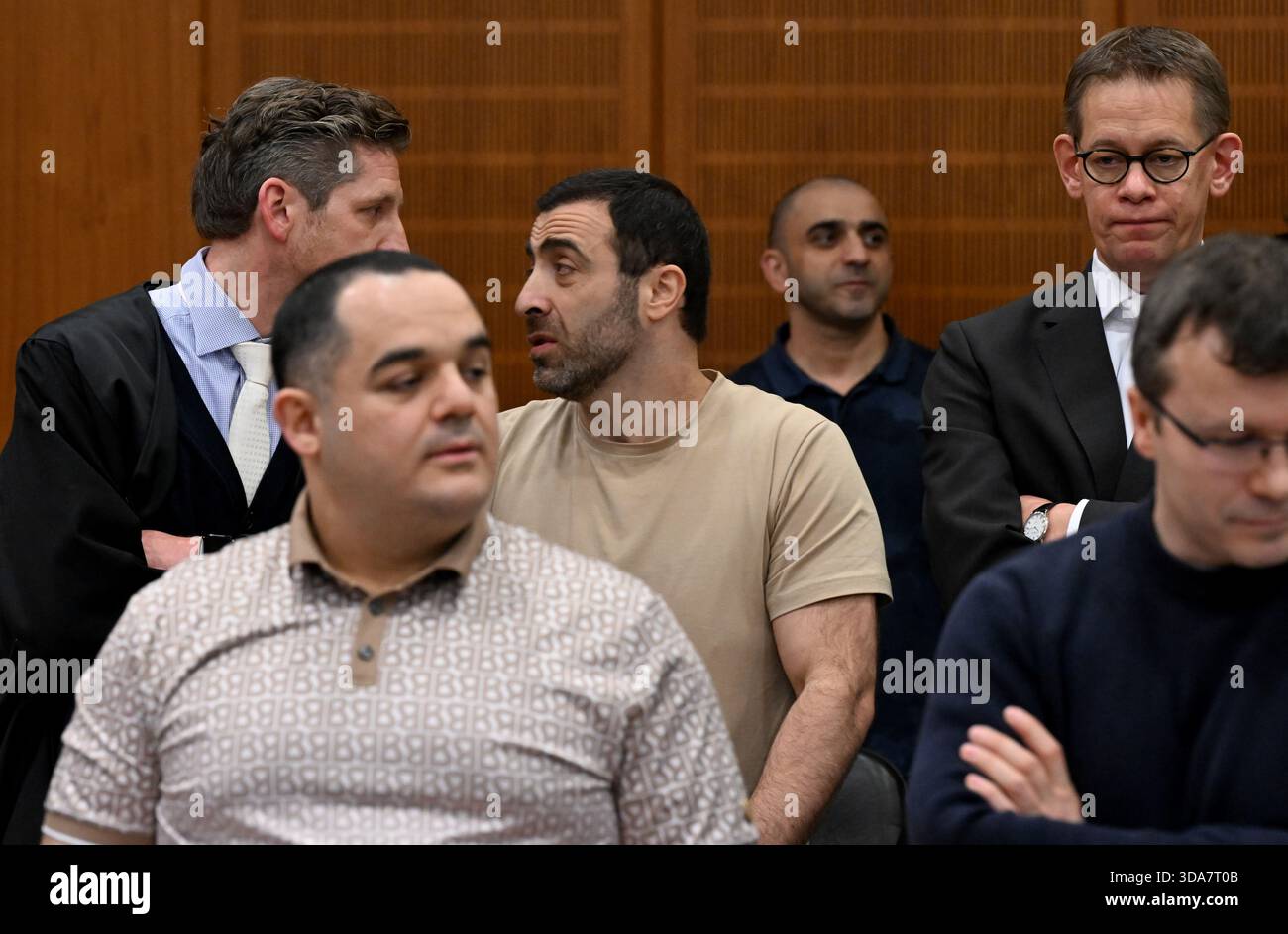 09 December 2025, Hesse, Frankfurt/Main: The three defendants ...