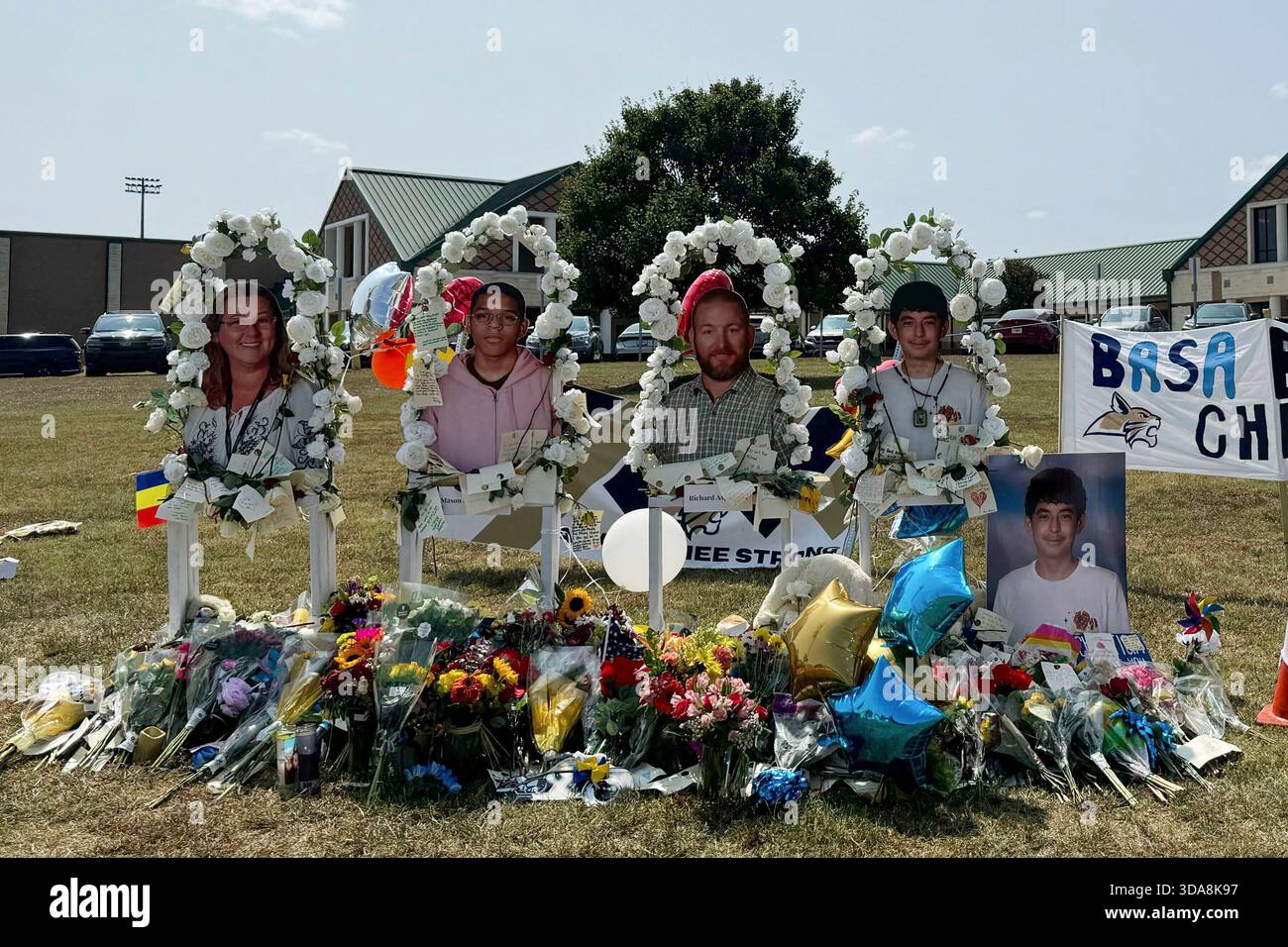 FILE - A poster with images of shooting victims from left, Cristina ...