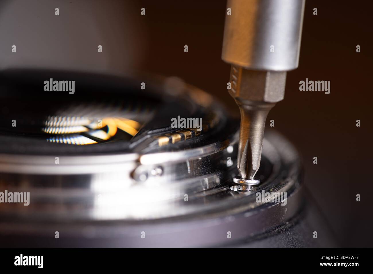 macro image of a screwdriver removing the screws form a full frame lens ...