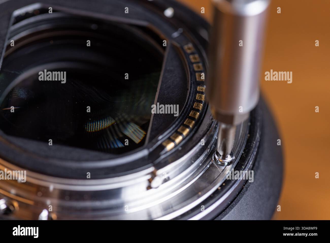 macro image of a screwdriver removing the screws form a full frame lens ...